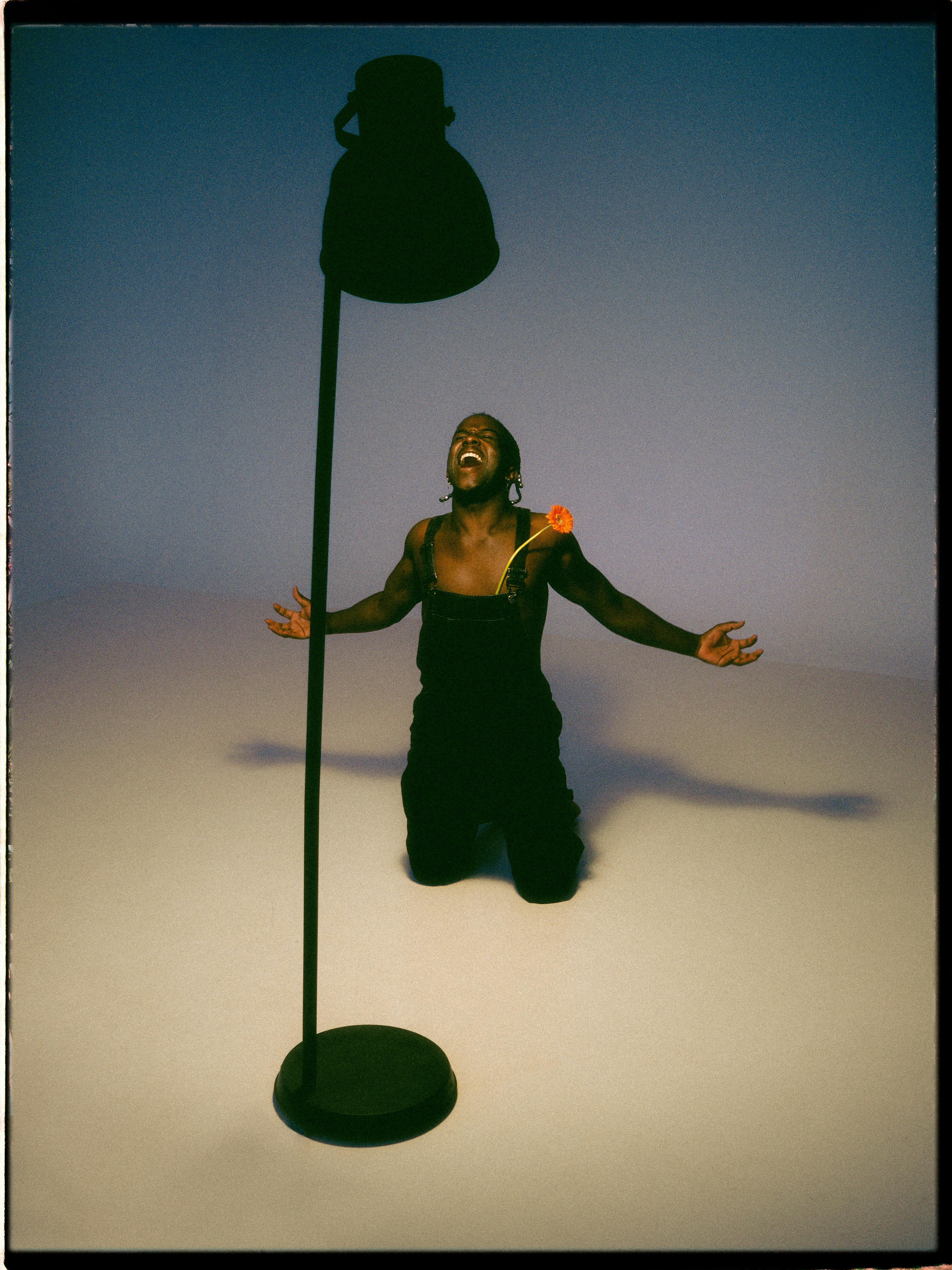 A man standing in front of a lamp · Free Stock Photo