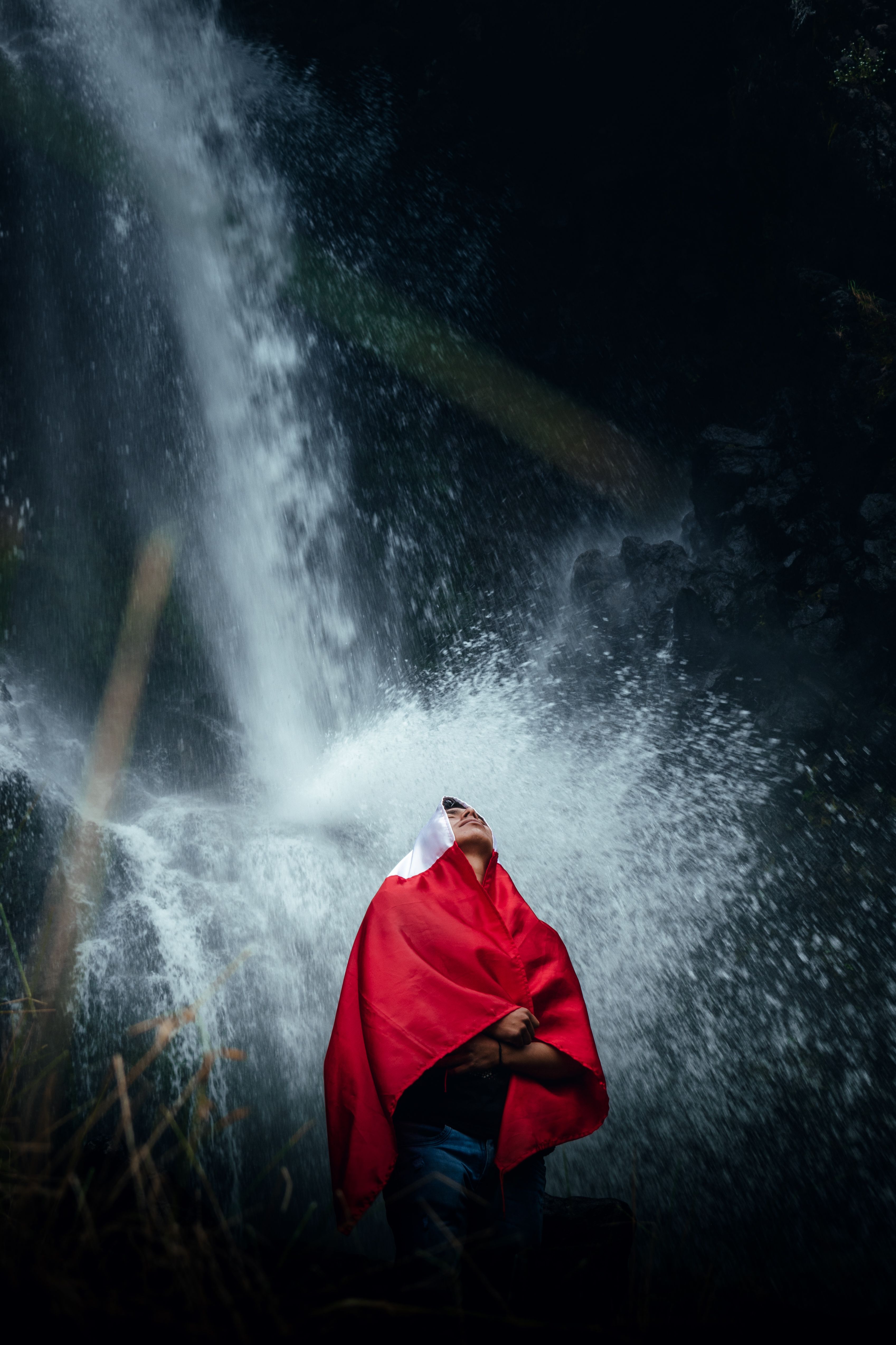 Man with Polish Flag Standing Under Waterfall · Free Stock Photo