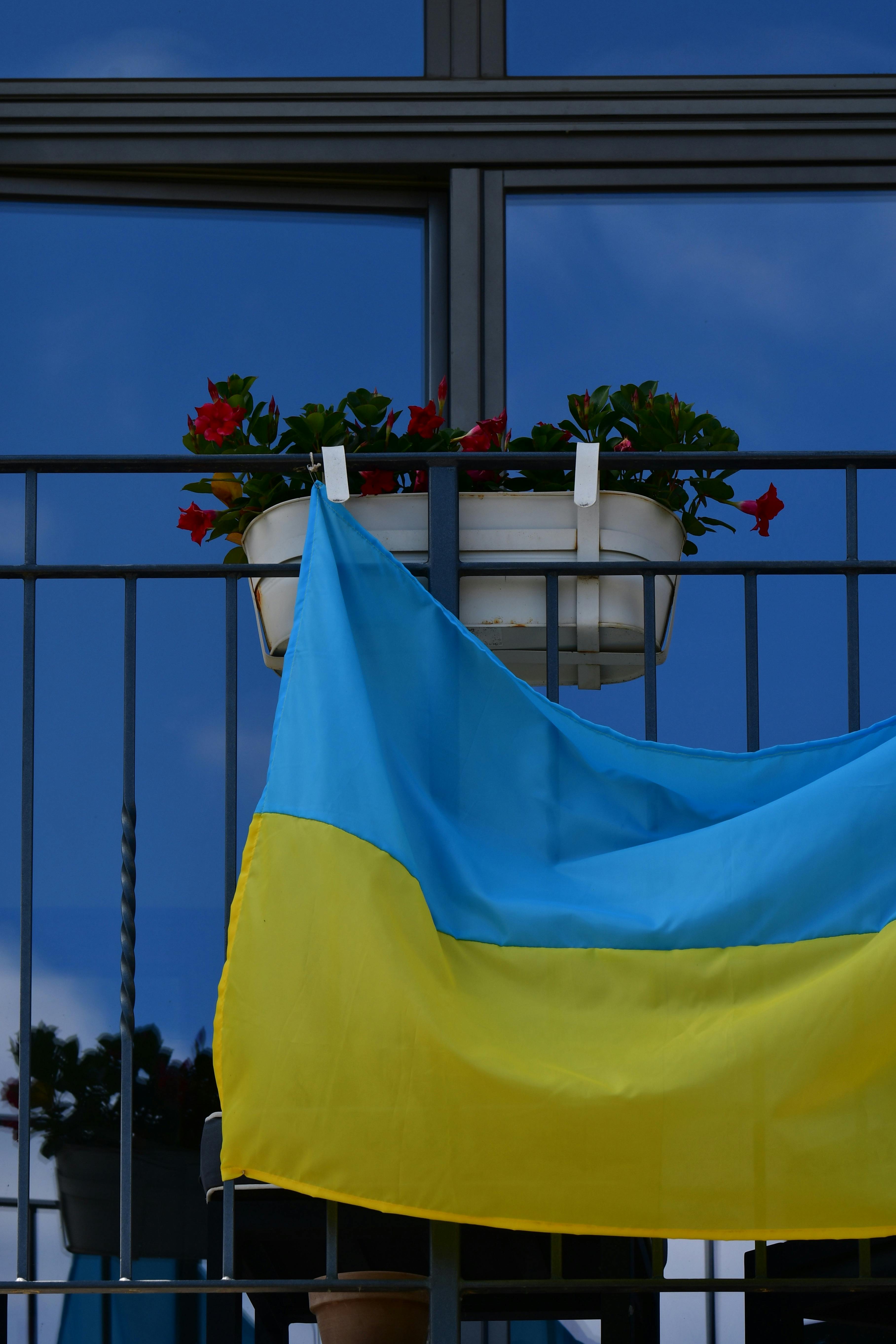 Ukrainian Flag Hanging on the Balcony · Free Stock Photo
