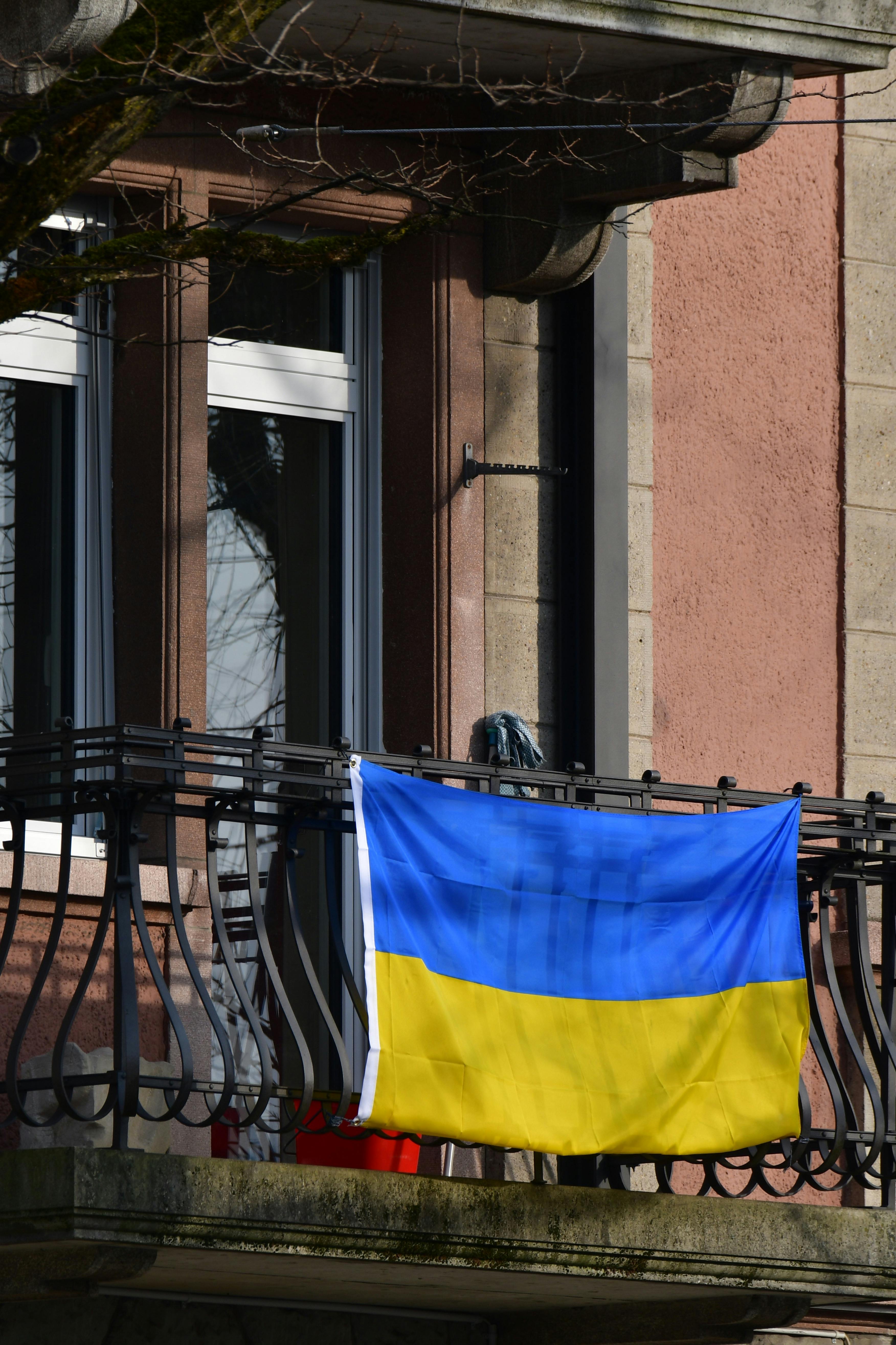 Ukrainian Flag Hanging on a Balcony · Free Stock Photo