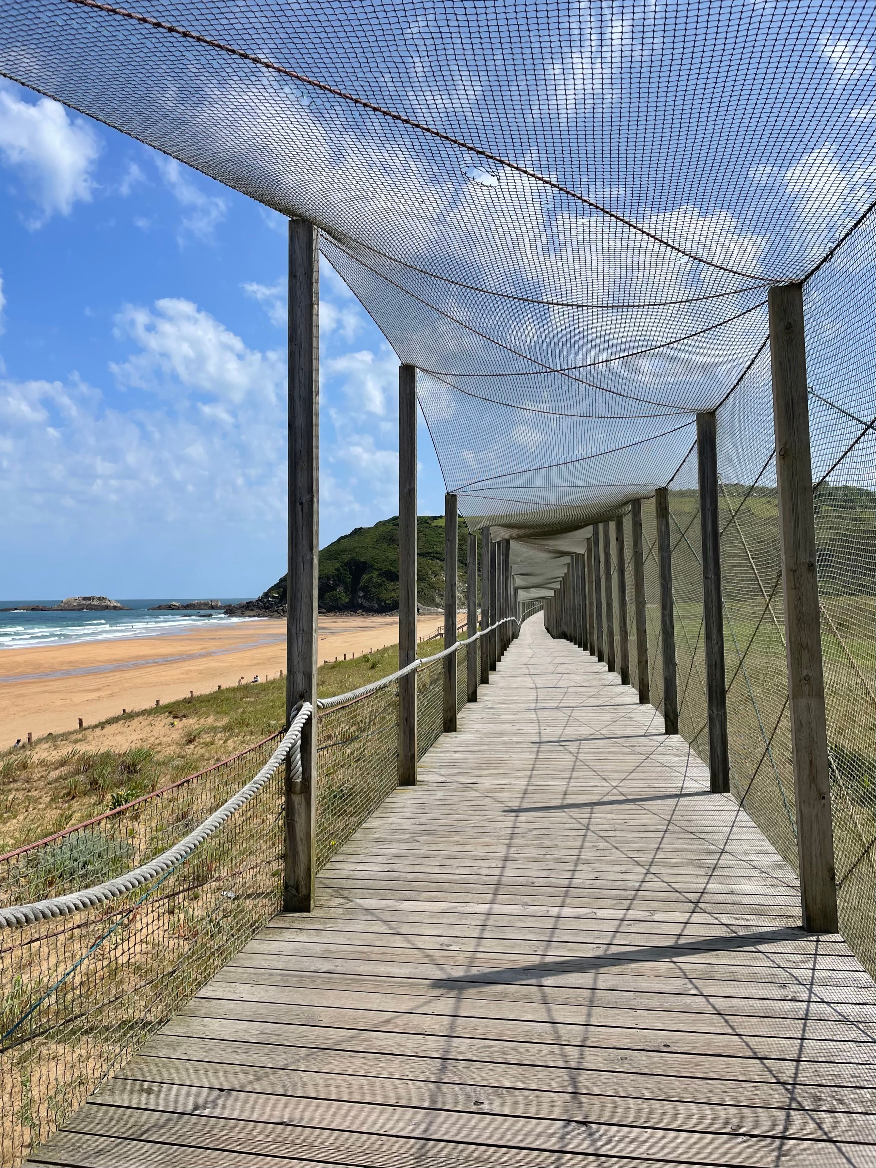 Boardwalk with a Net Covering Along the Beach · Free Stock Photo