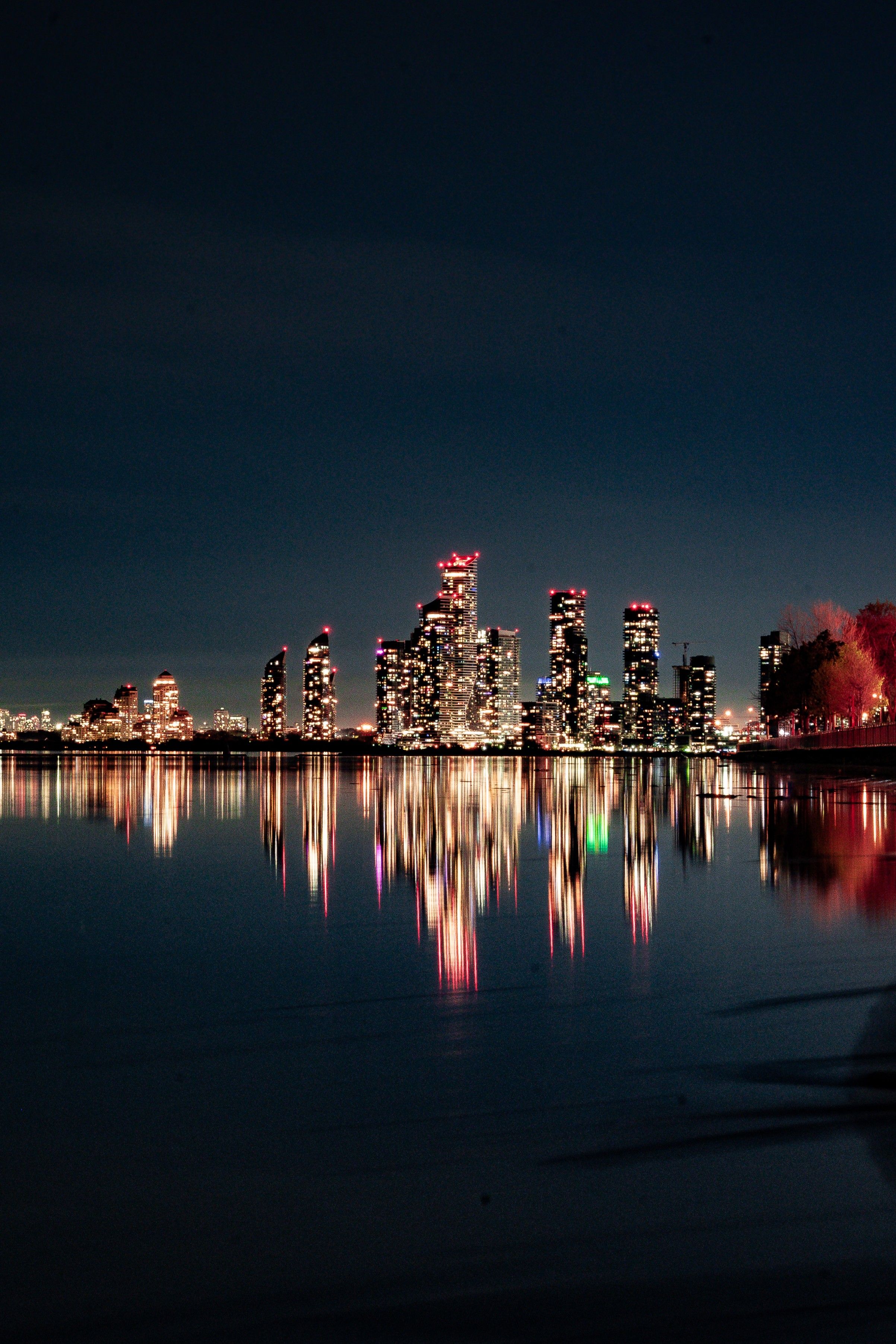 Illuminated City on Sea Coast at Night · Free Stock Photo