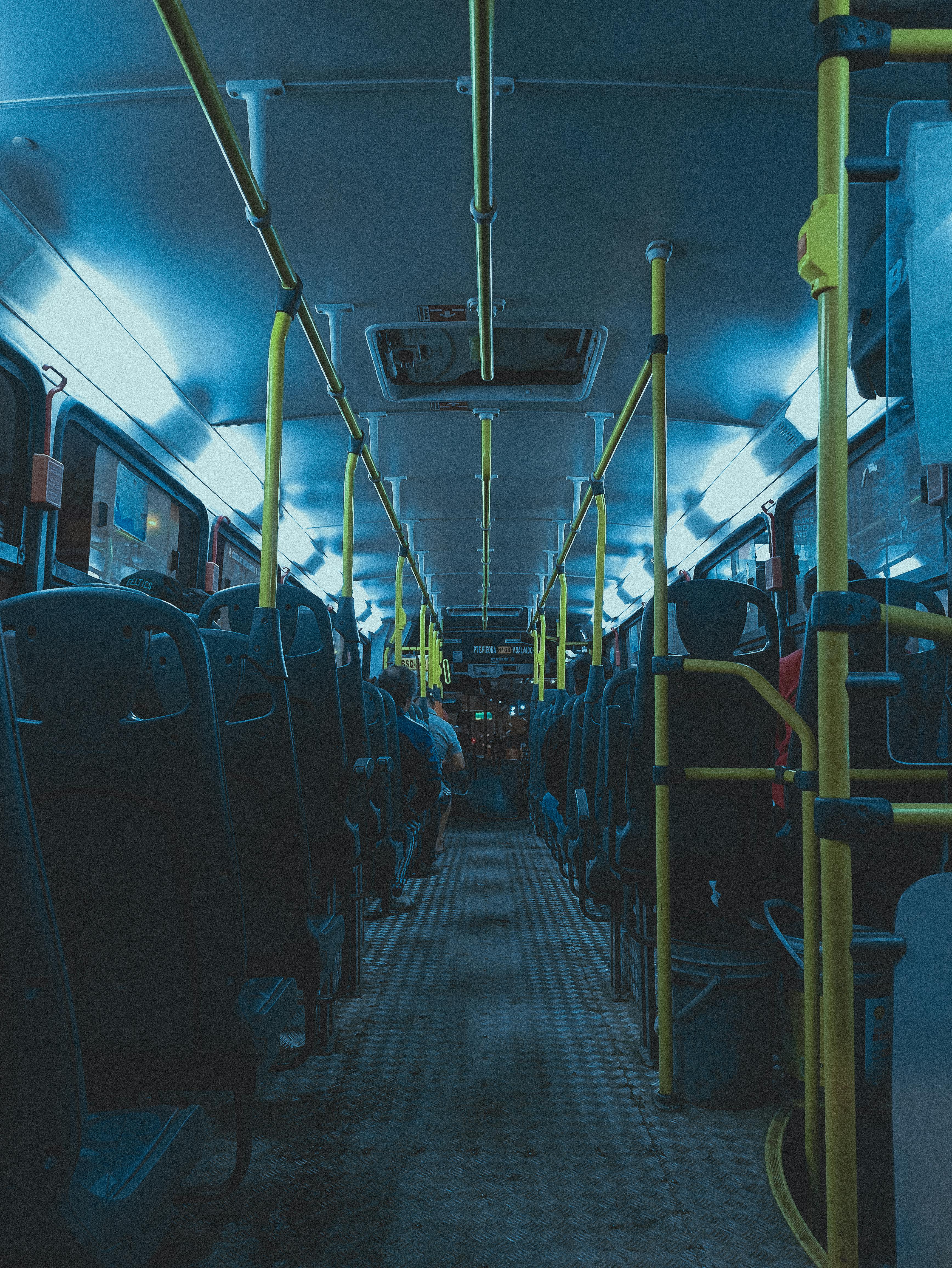 Free Dimly lit bus interior at night with empty seats and neon lights ...