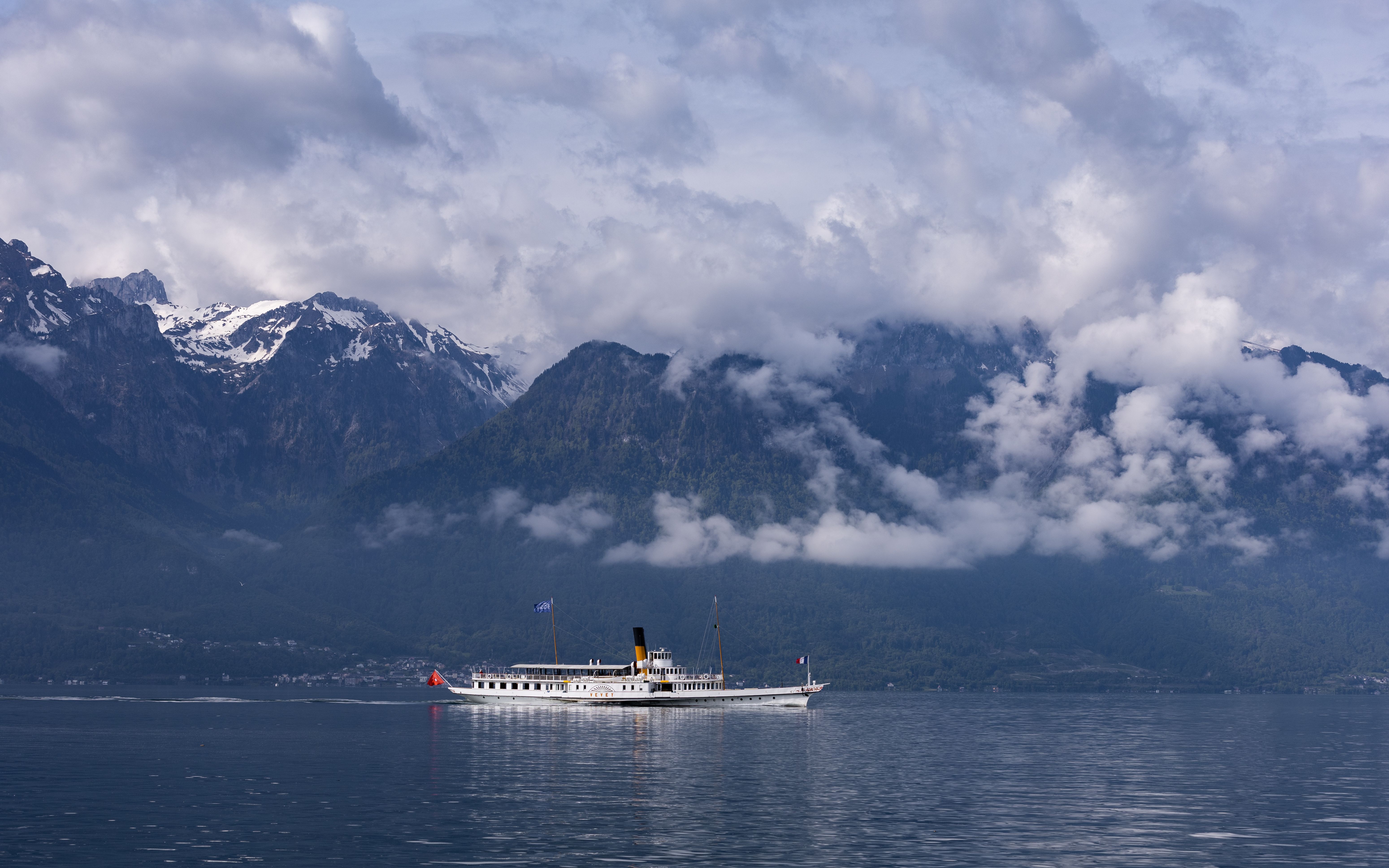 Ferry Sailing across Lake in Mountains Obscured by Thick Clouds · Free ...