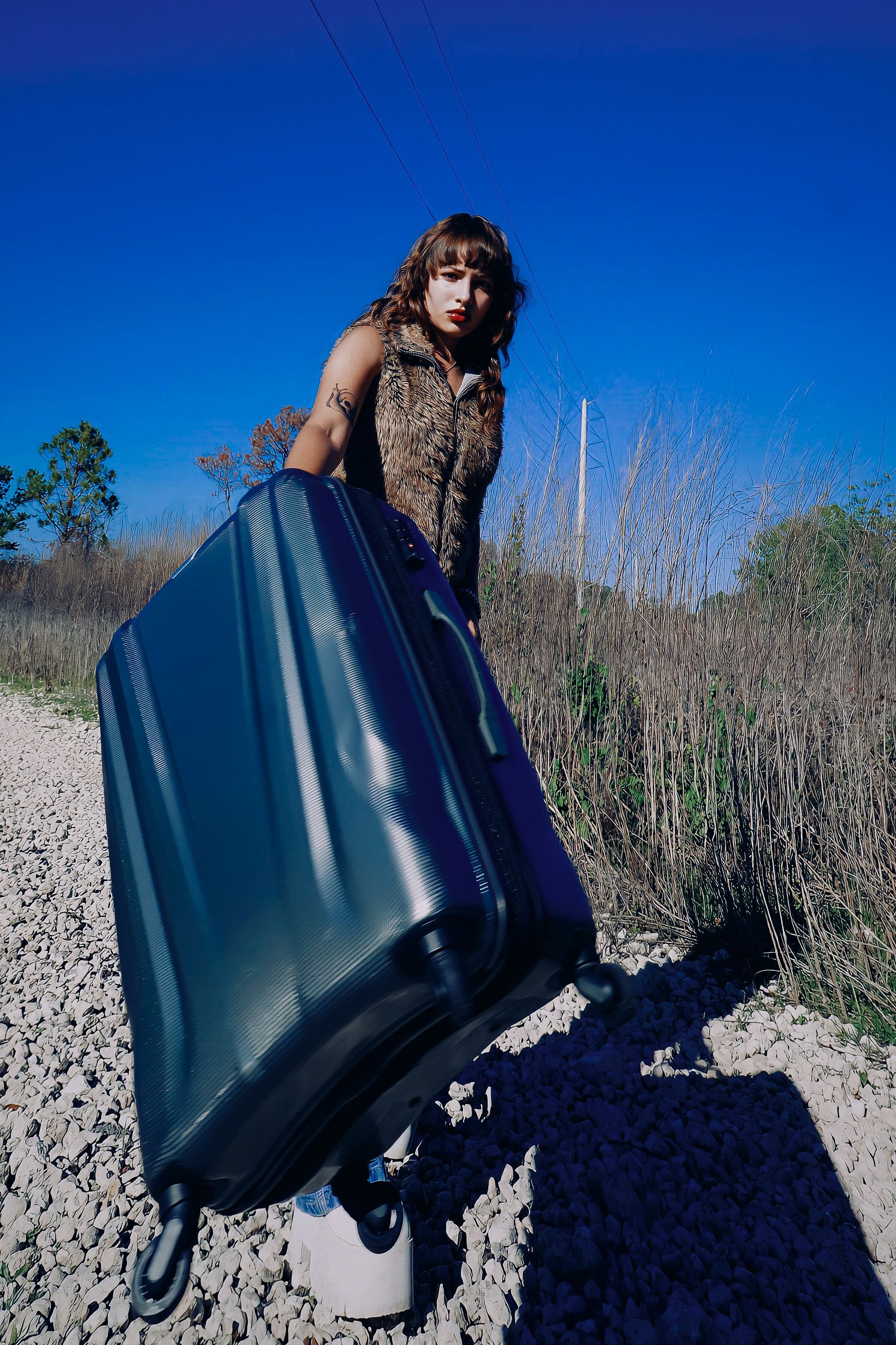 Woman Standing and Posing with Suitcase · Free Stock Photo
