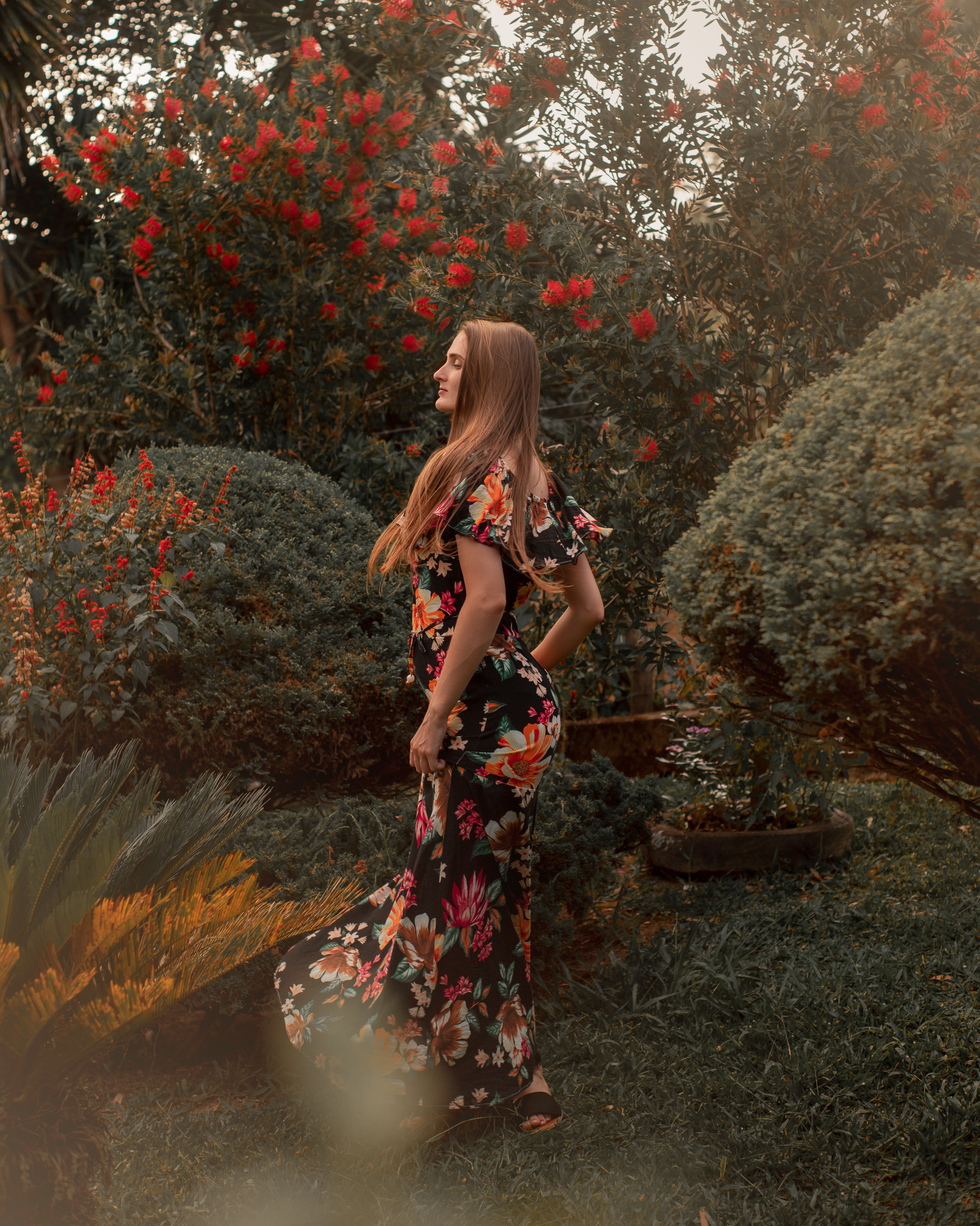 Blonde Model in Blue Dress Standing behind Bush · Free Stock Photo
