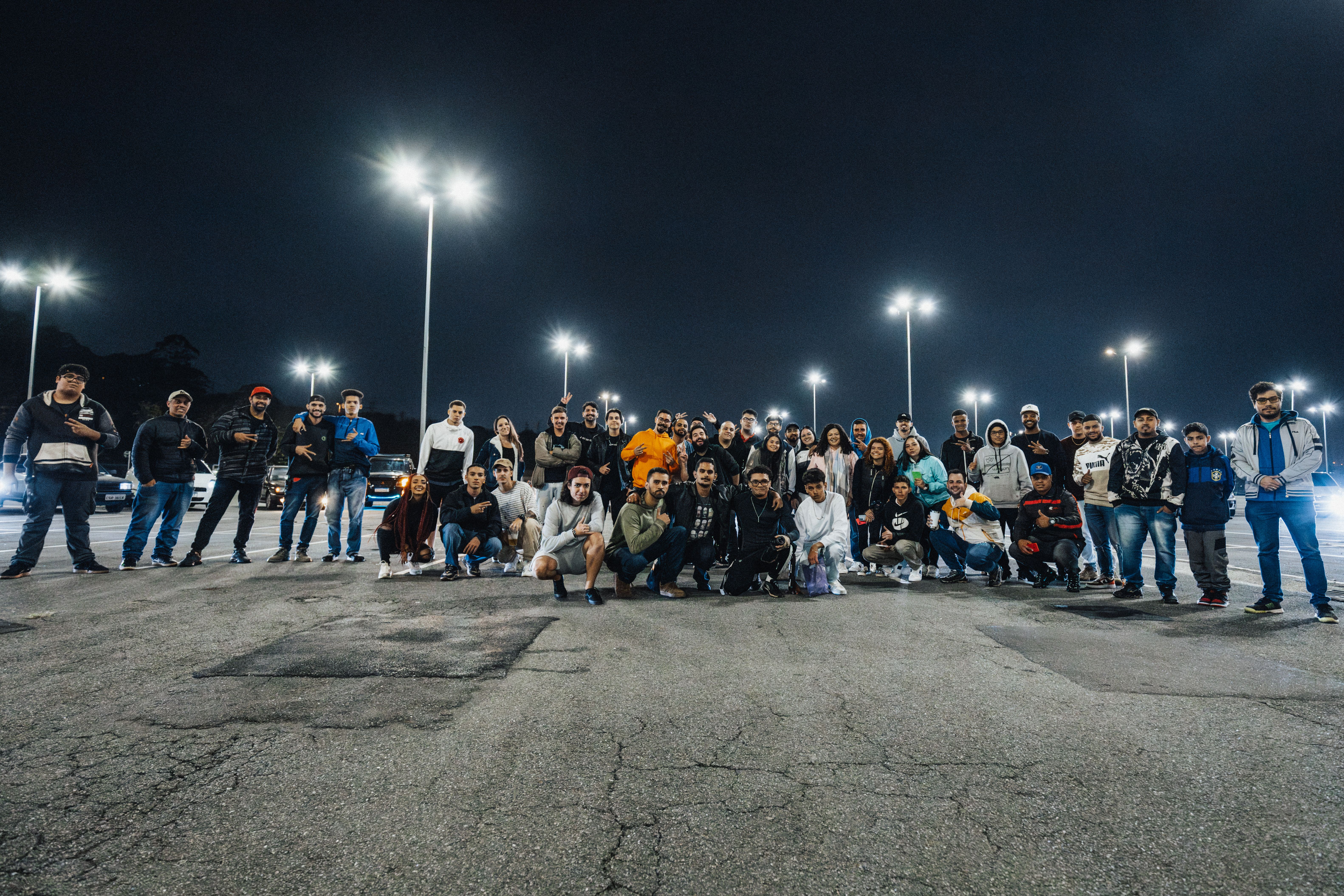 A Group of People Posing for a Picture at the Parking Lot · Free Stock ...