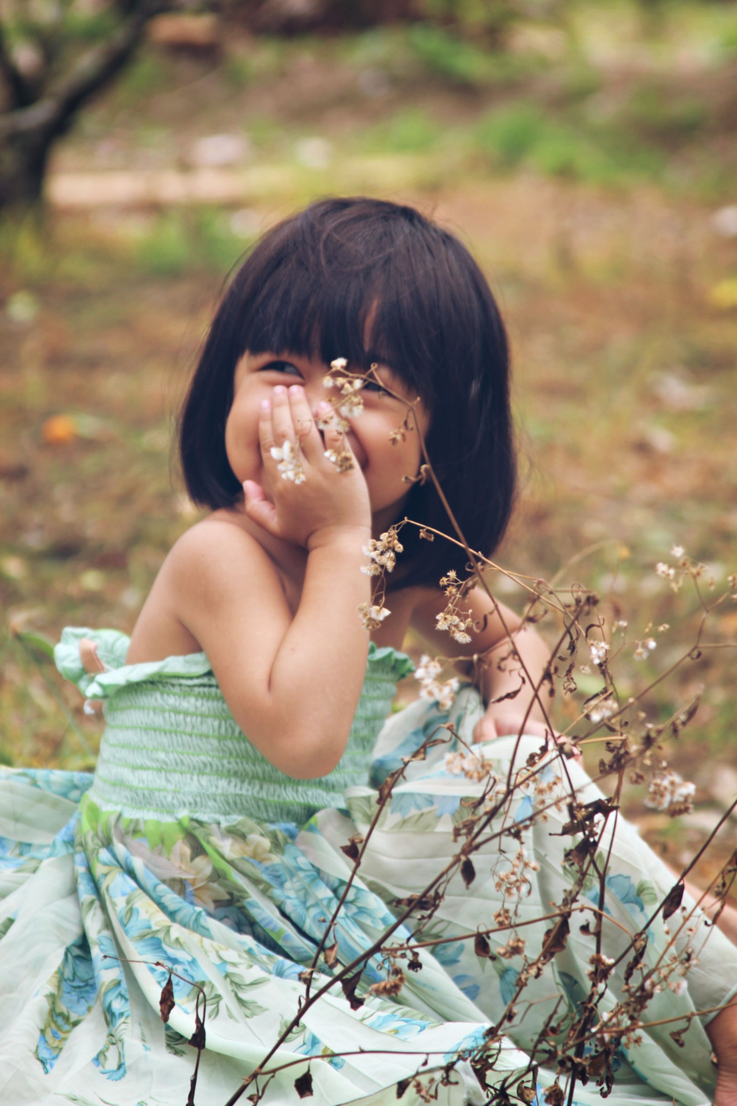 Little Girl Covering her Smile · Free Stock Photo