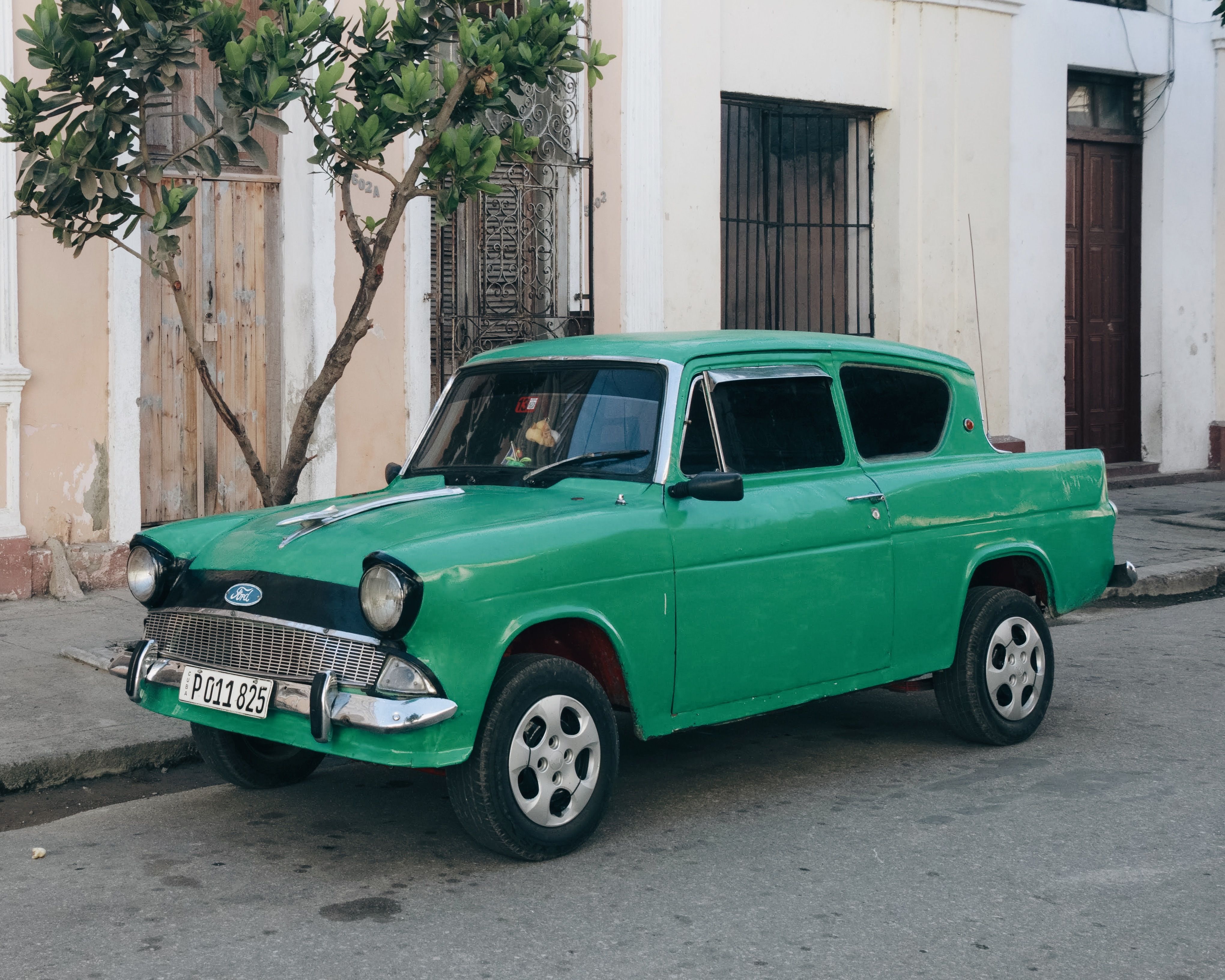 A Vintage Green Ford Anglia Parked on the Side of the Street · Free ...