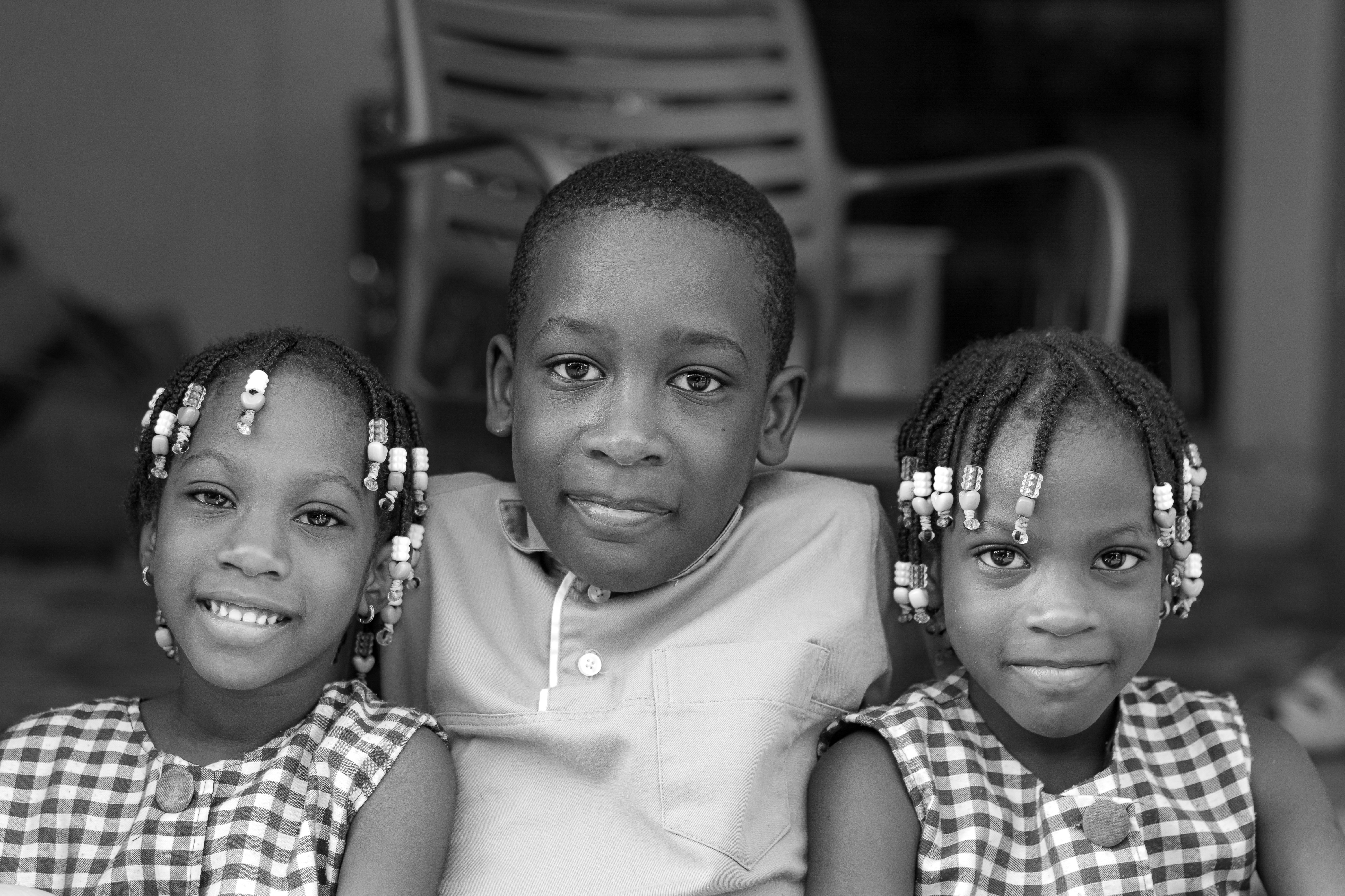 Black and White Photo of Children Sitting Together · Free Stock Photo