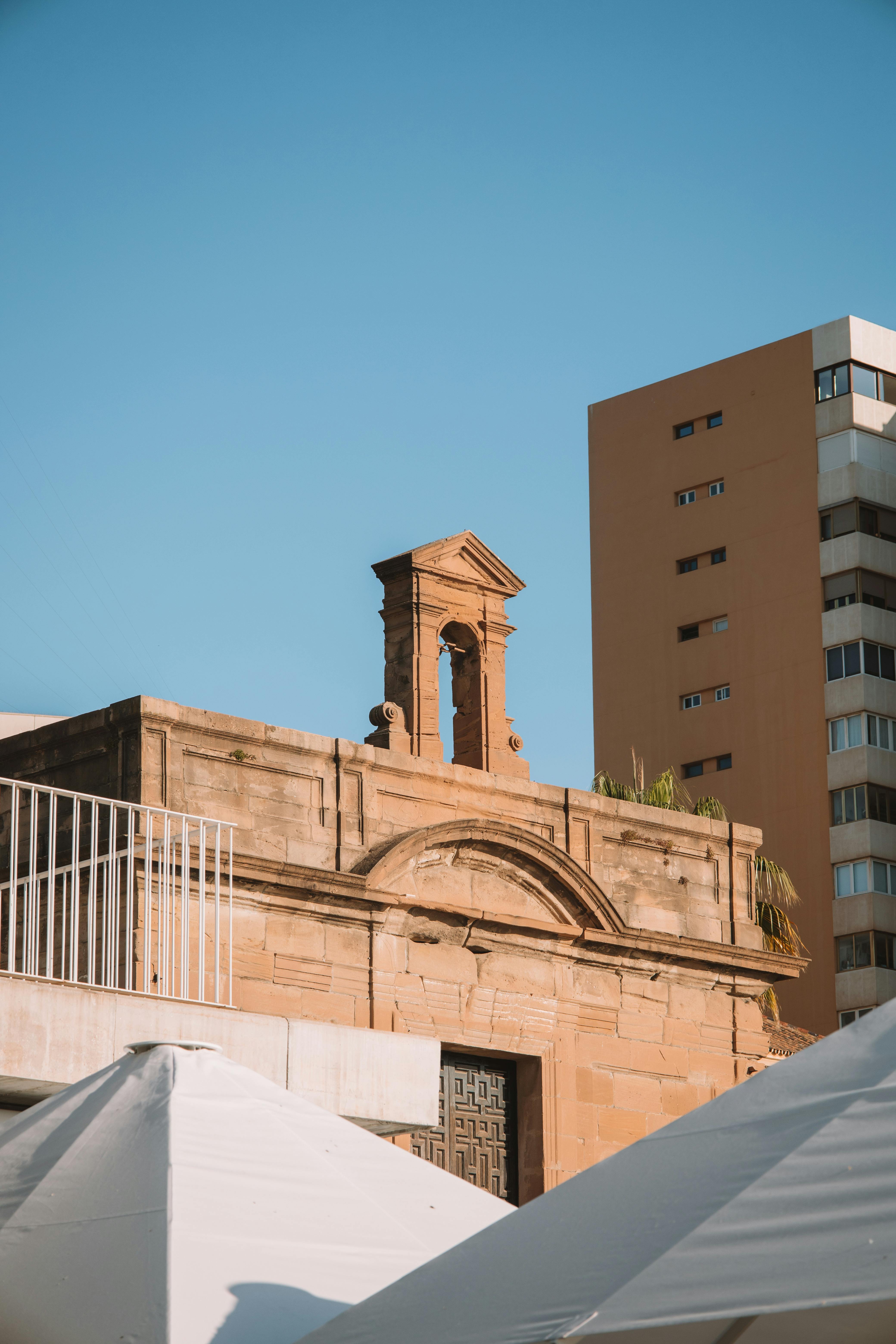 Man Standing in Concrete Arches · Free Stock Photo