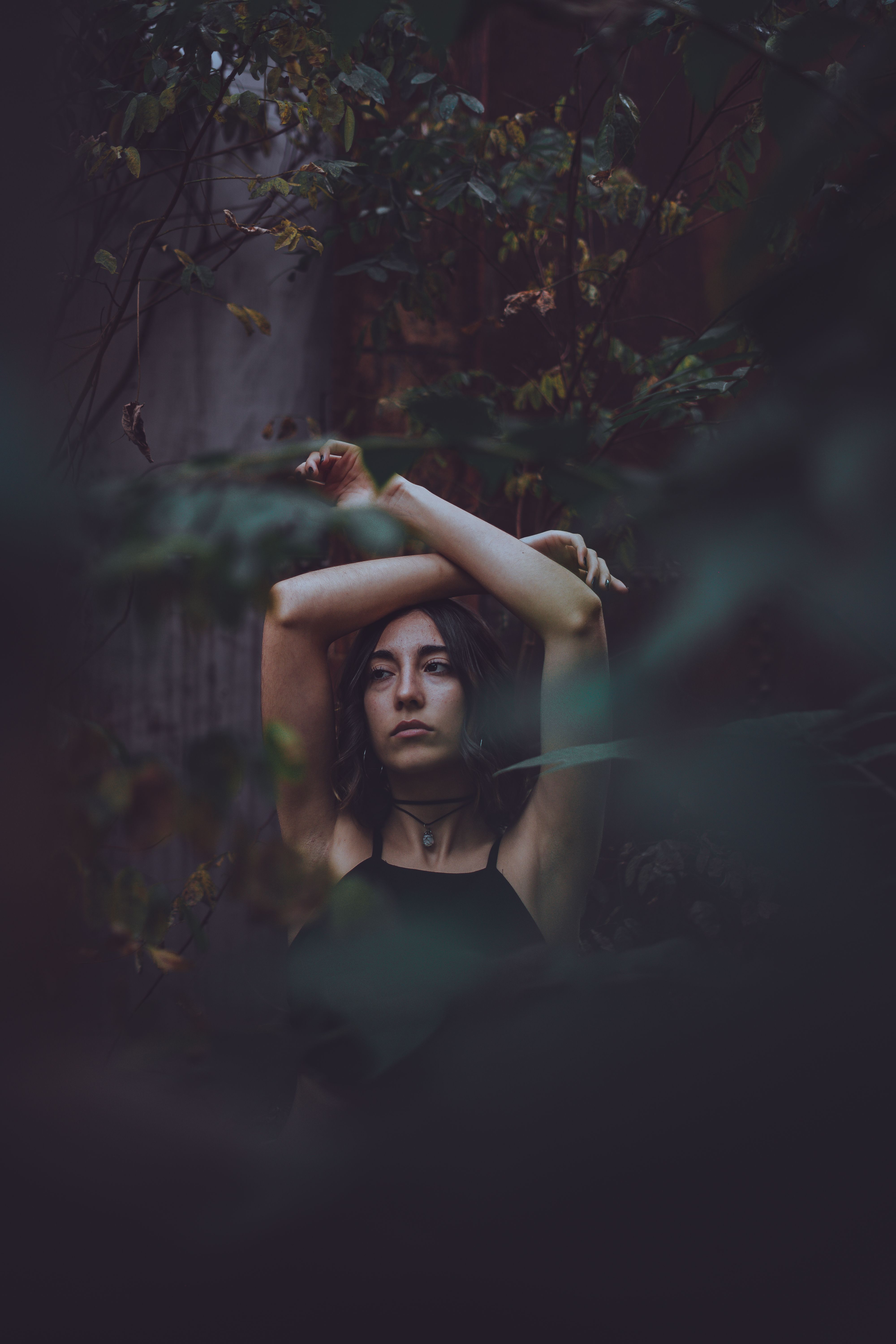 Woman Crosses Arms over Head in Forest · Free Stock Photo