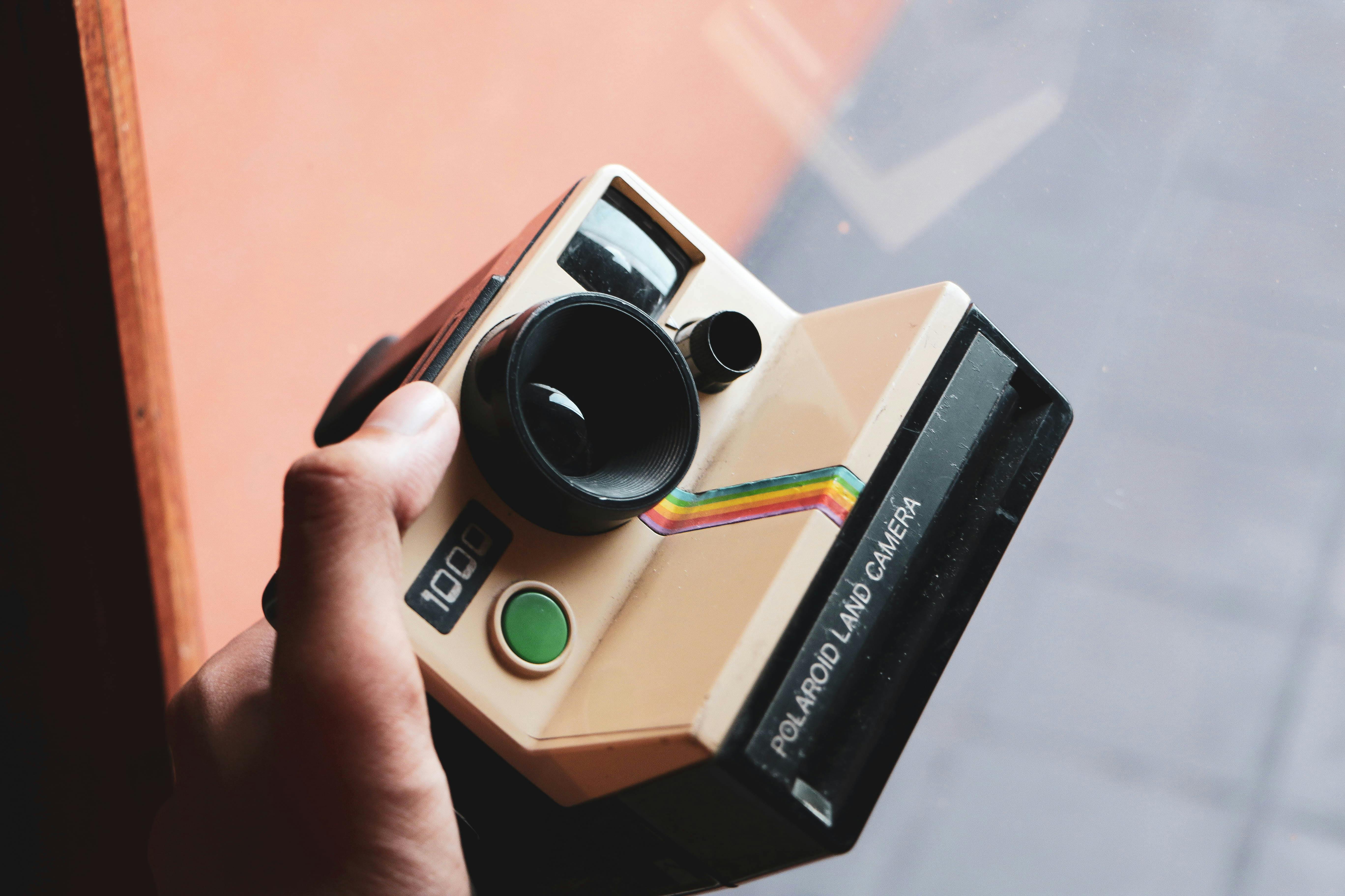 Person Holding Gray Polaroid Land Camera · Free Stock Photo