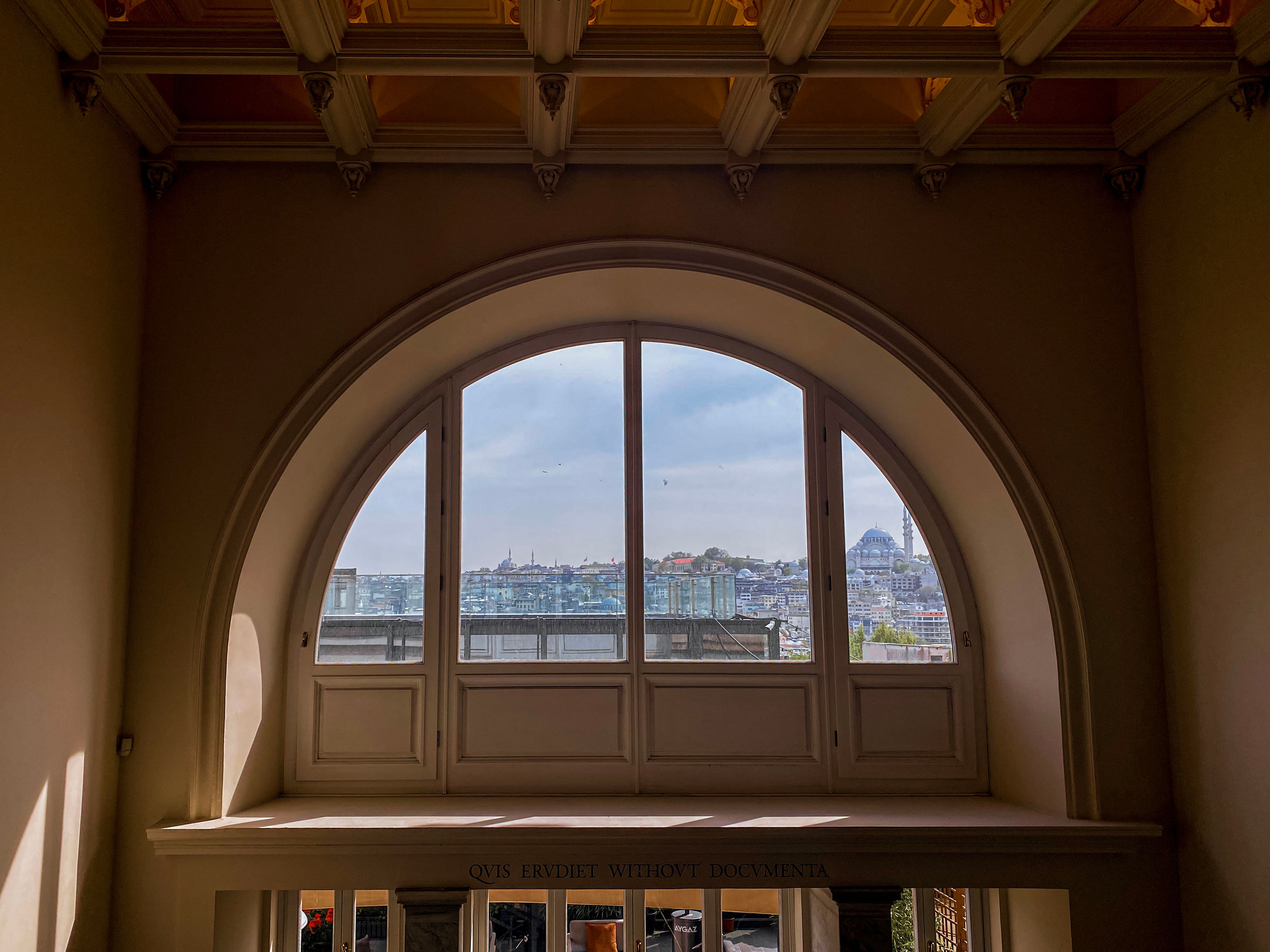 Arch of a Window Overlooking a City · Free Stock Photo