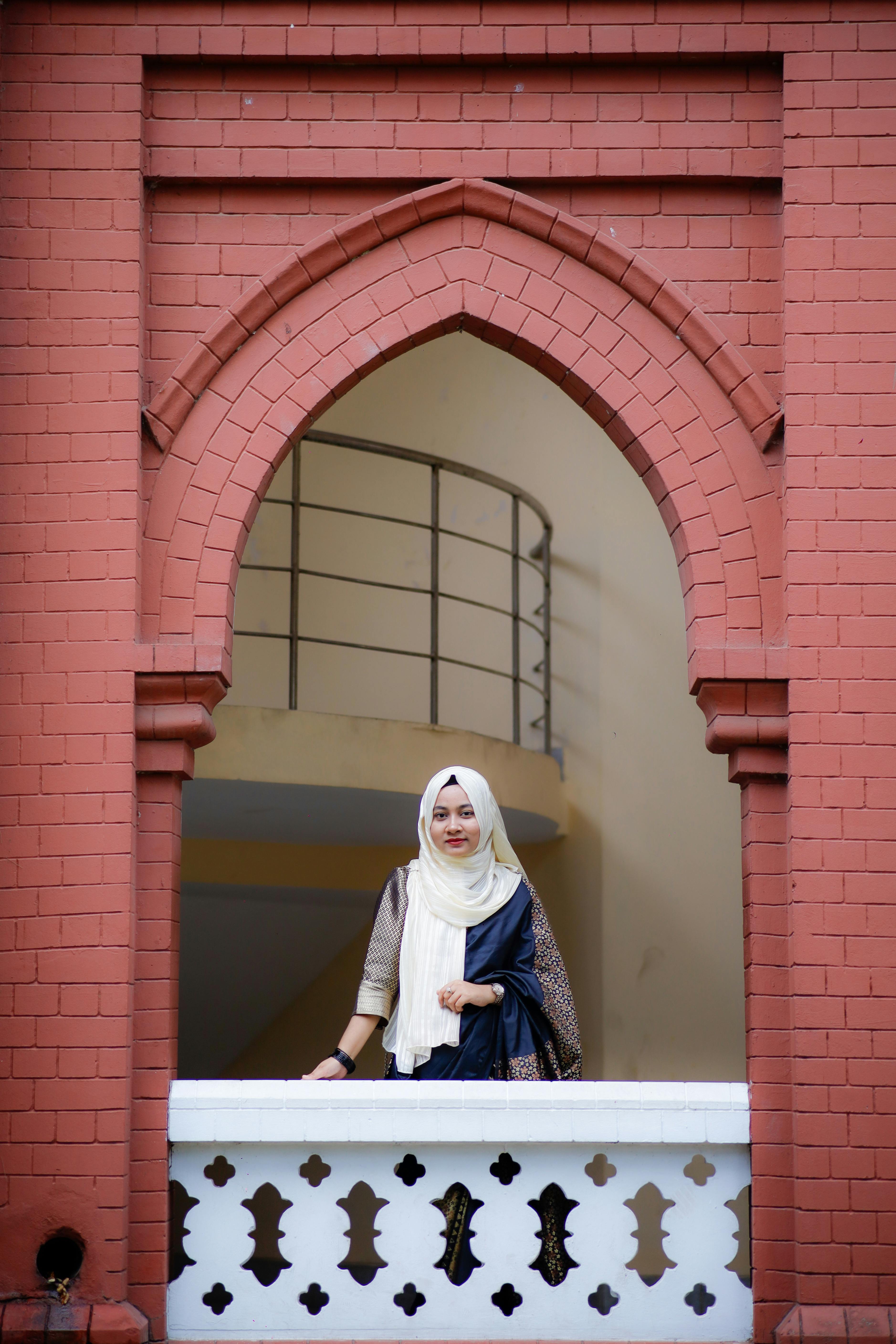 Woman in Dress Standing under Building Arches · Free Stock Photo