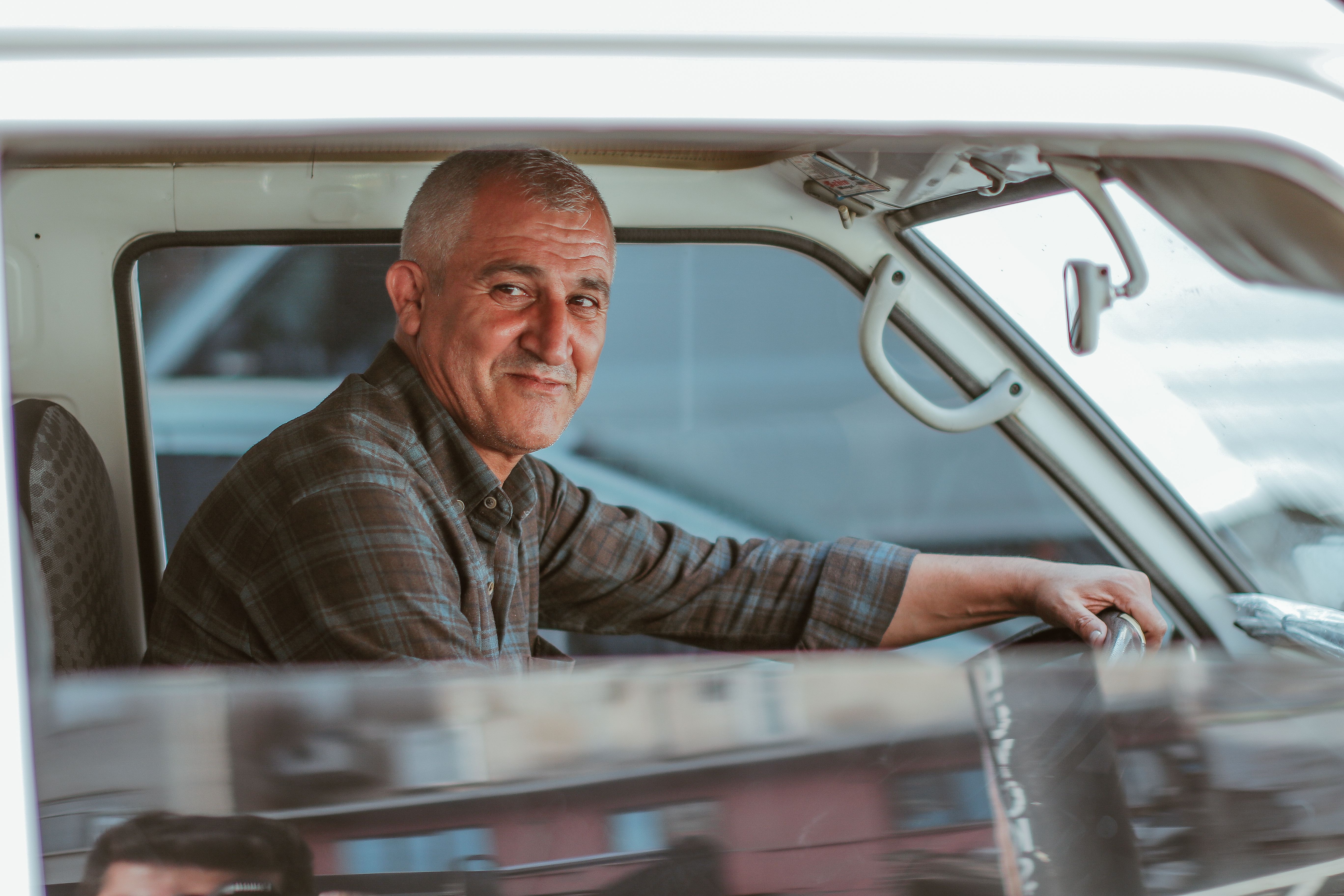 Smiling Man Driving Car · Free Stock Photo