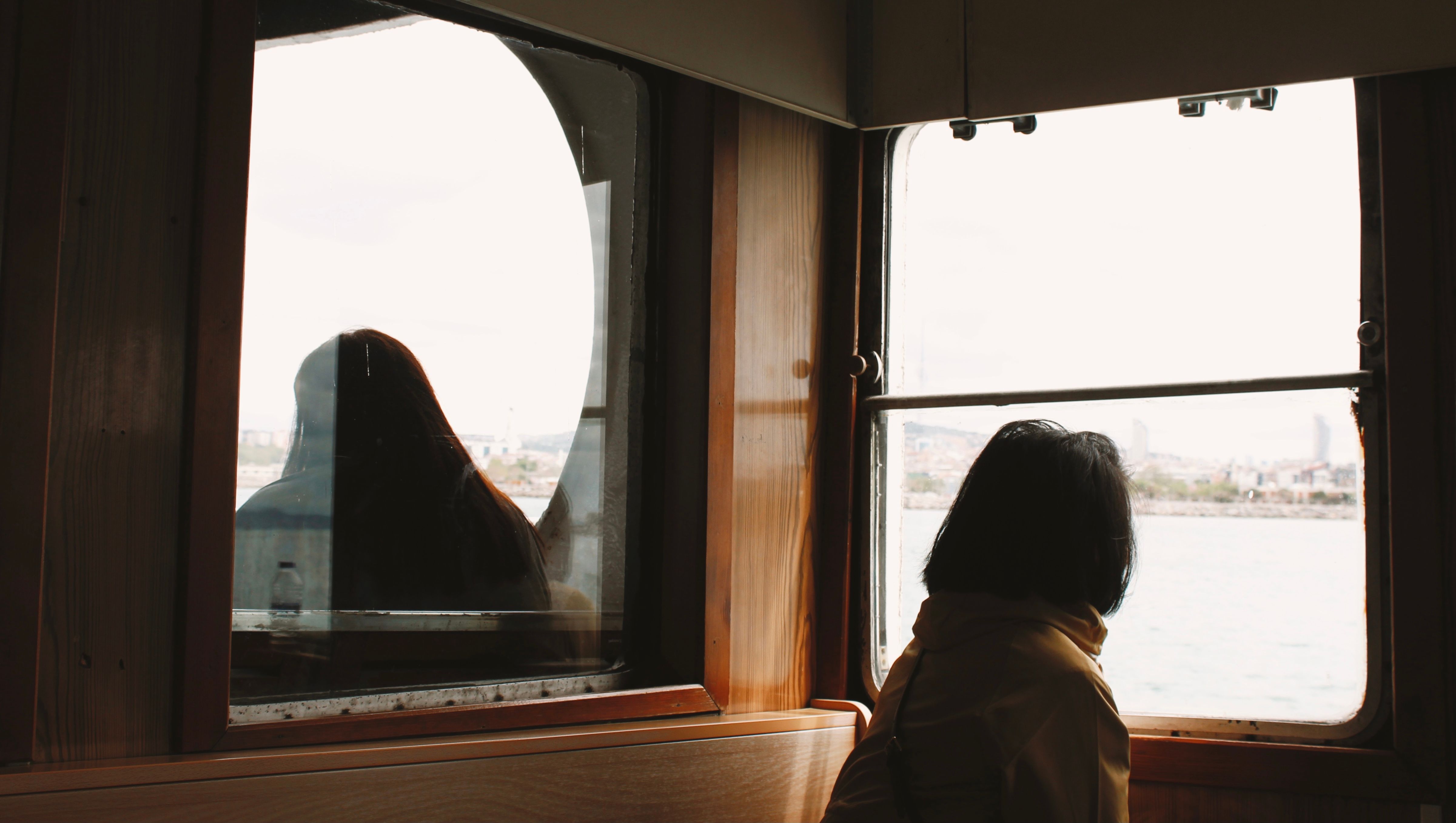Woman Looking out the Window in a Ferry · Free Stock Photo