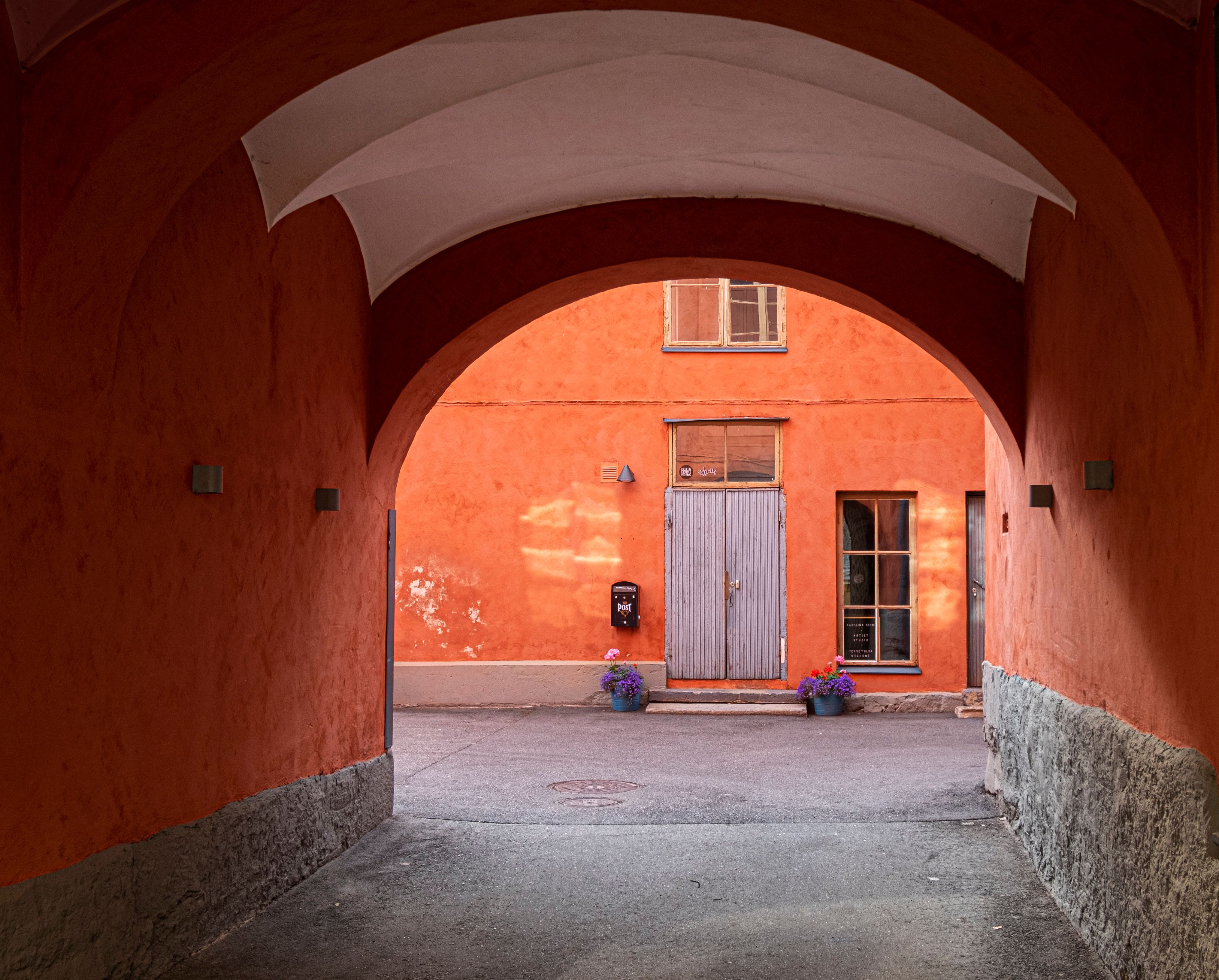 An Arched Passage in a Red Building in City · Free Stock Photo