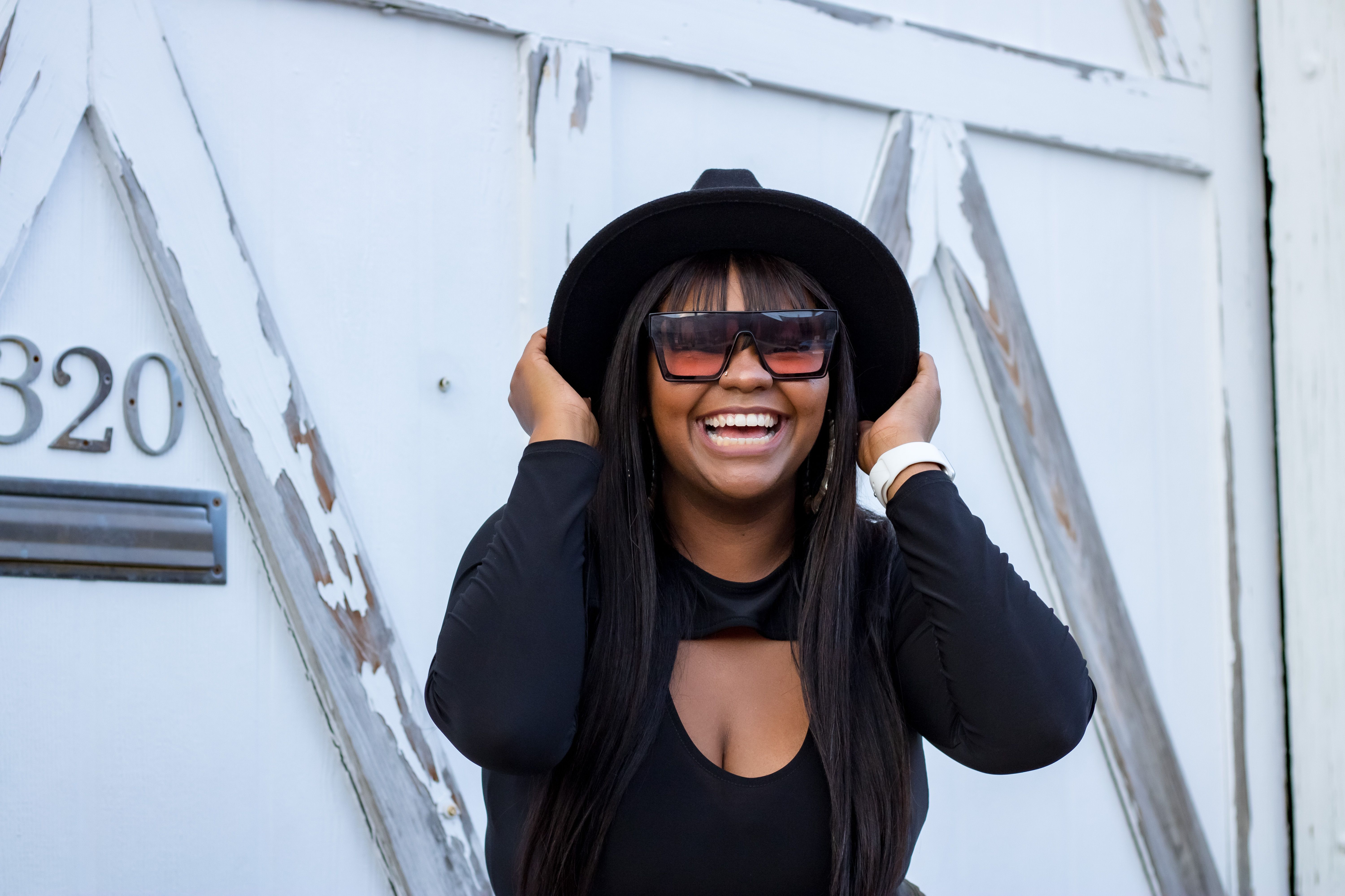 Smiling Woman Holding Hands on Hat · Free Stock Photo