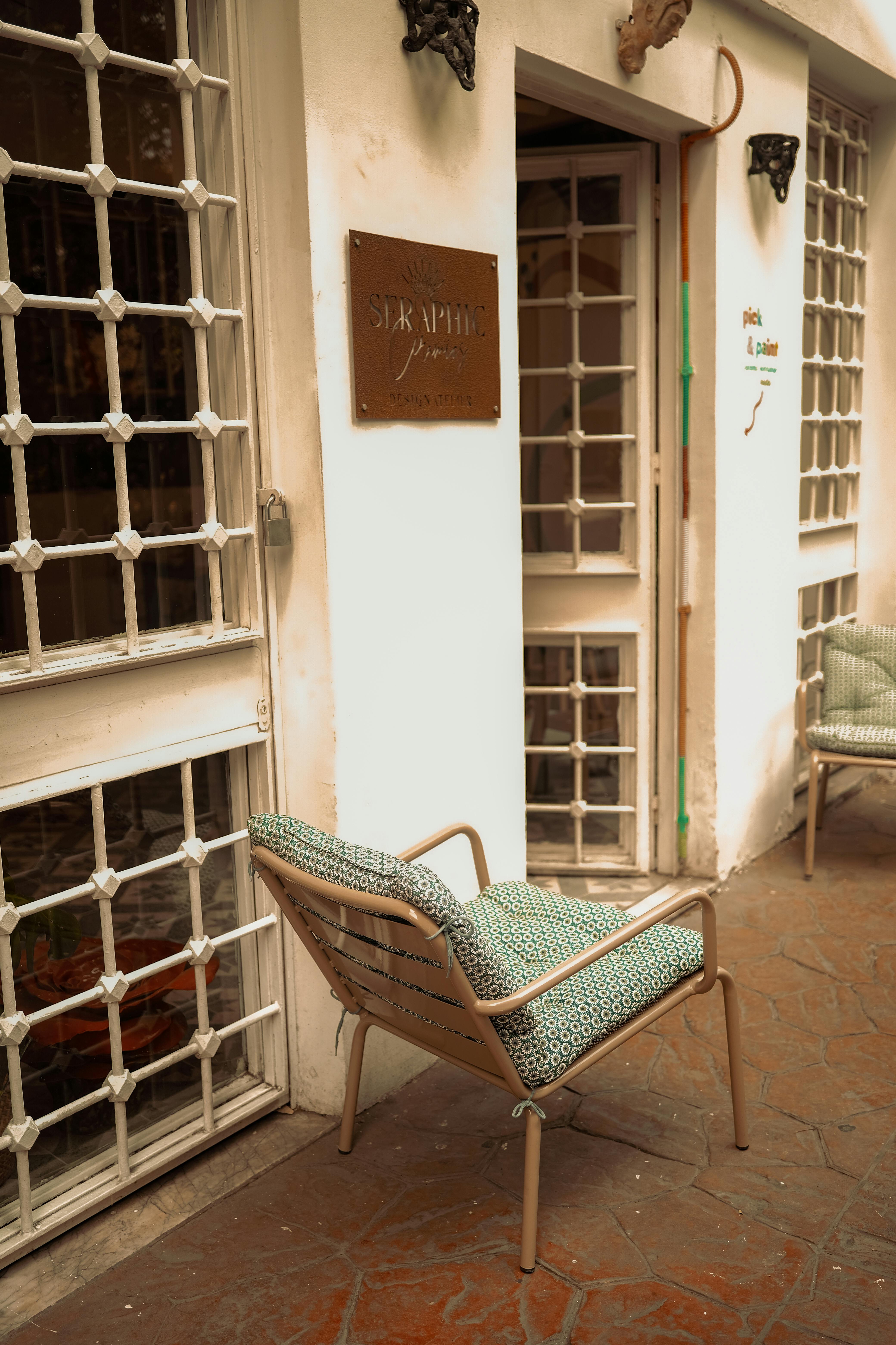 A Steel Framed Glass Structure with Table and Chairs · Free Stock Photo