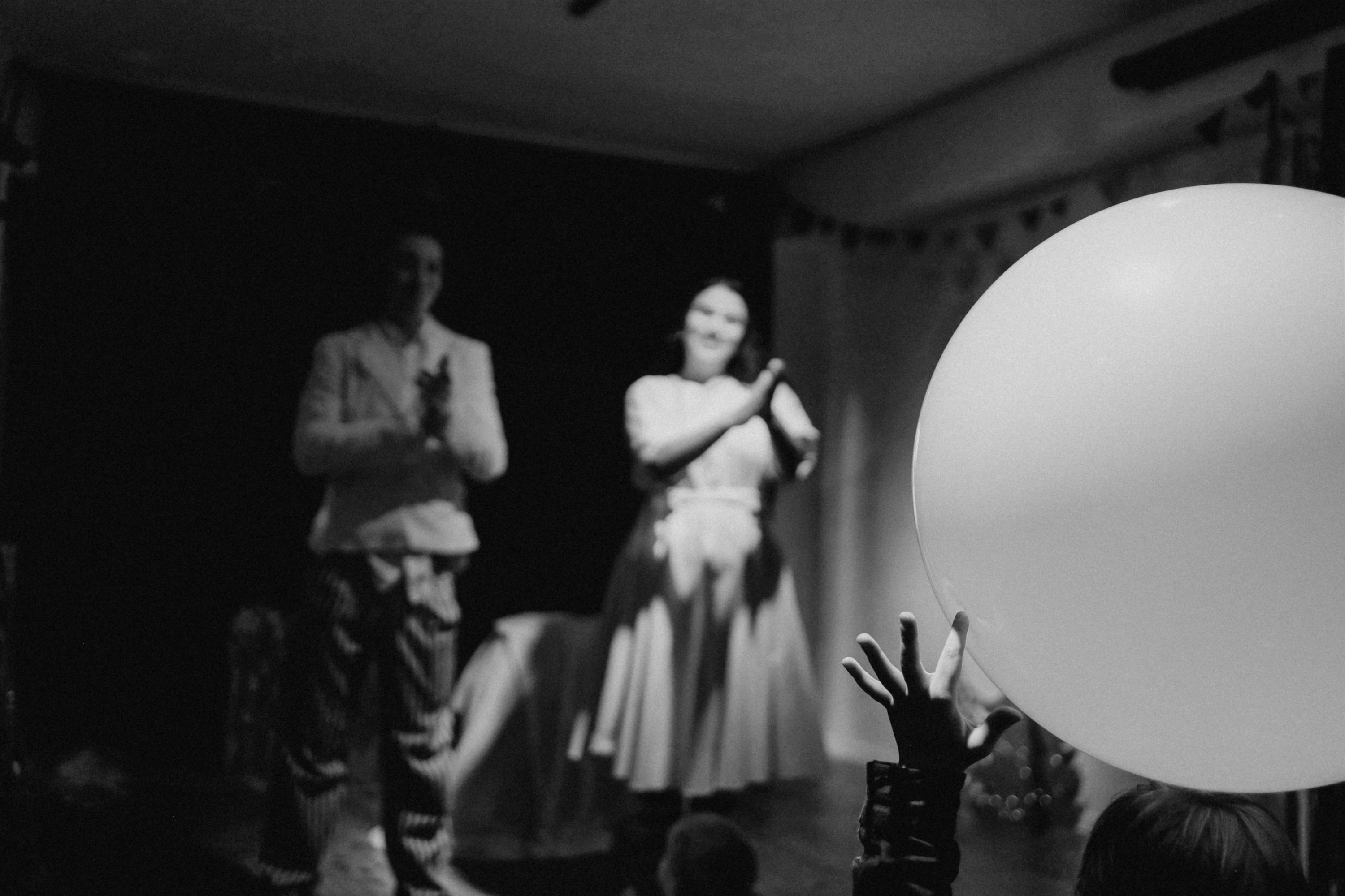Balloon in Child Hands Against Singers on Stage · Free Stock Photo