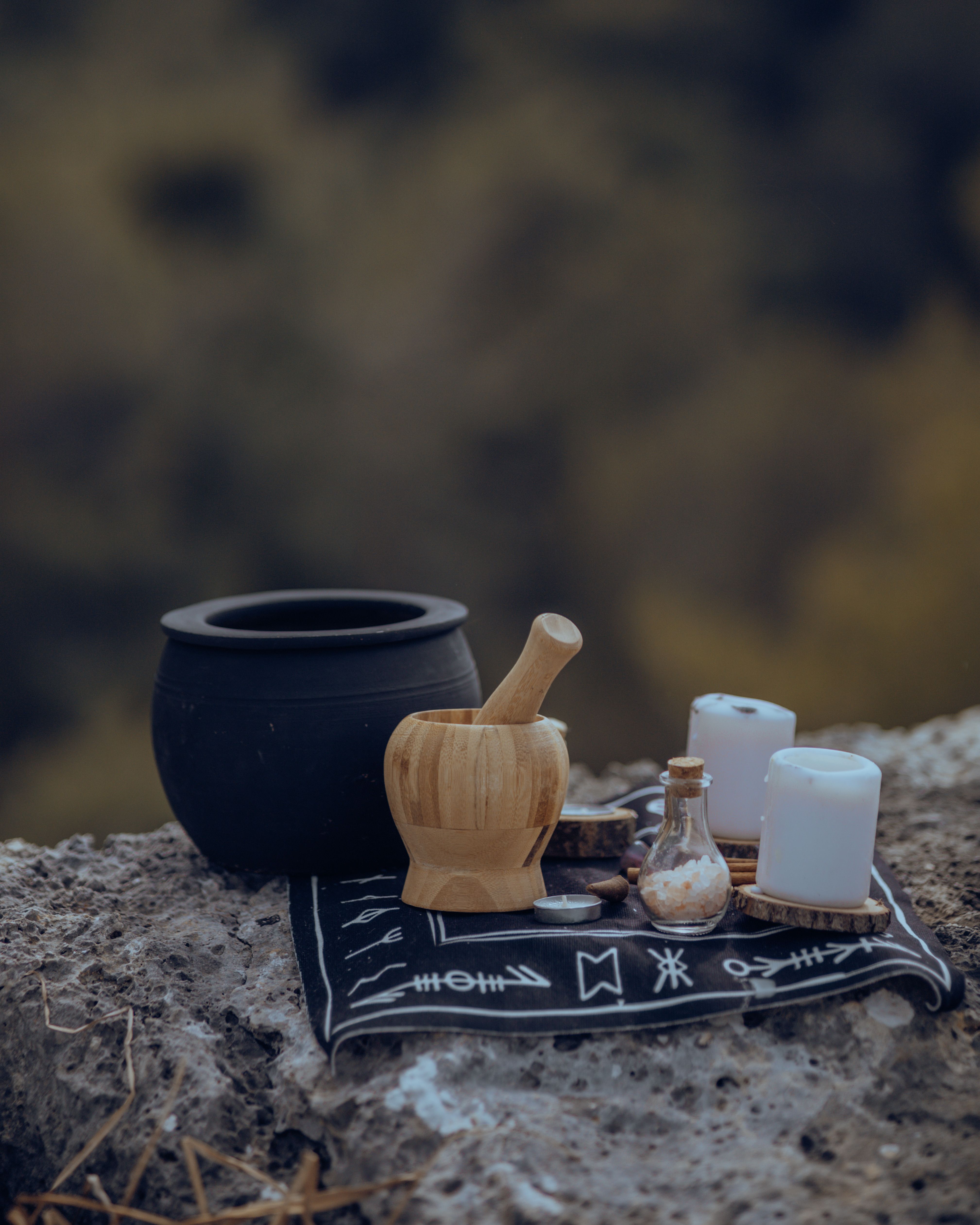 A Pot, a Mortar and Candles on a Rocky Surface · Free Stock Photo