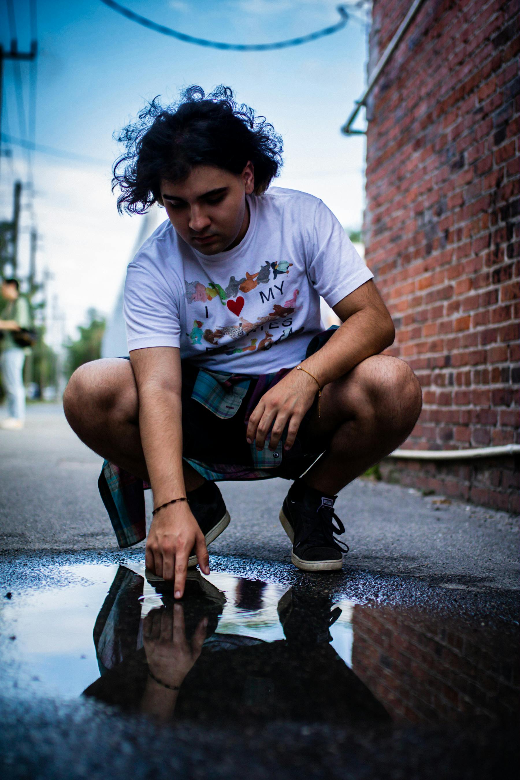 Mans Hand Crouching in the Street and Touching a Rain Puddle · Free ...