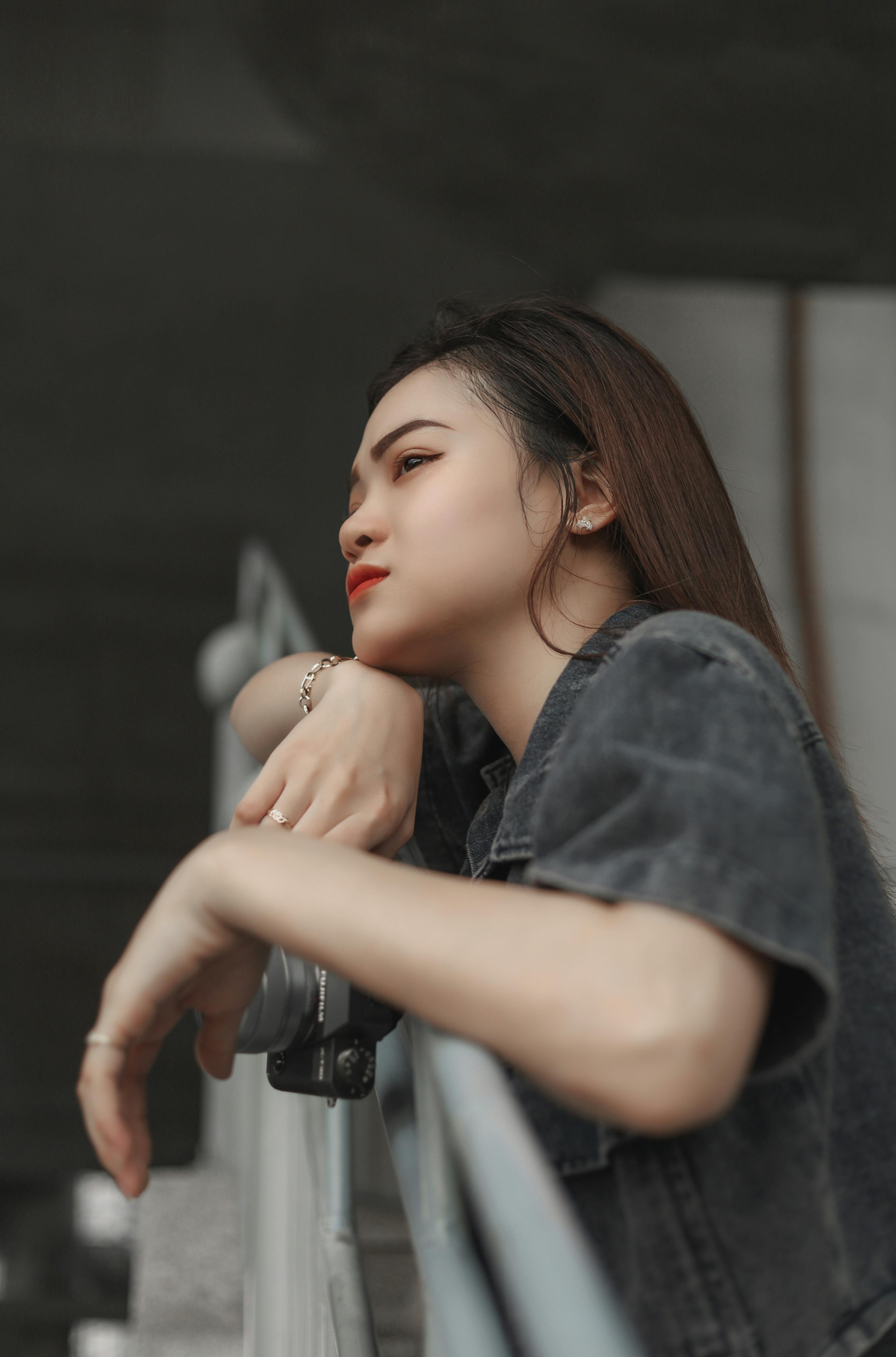 Woman Leaning on Railing and Posing · Free Stock Photo