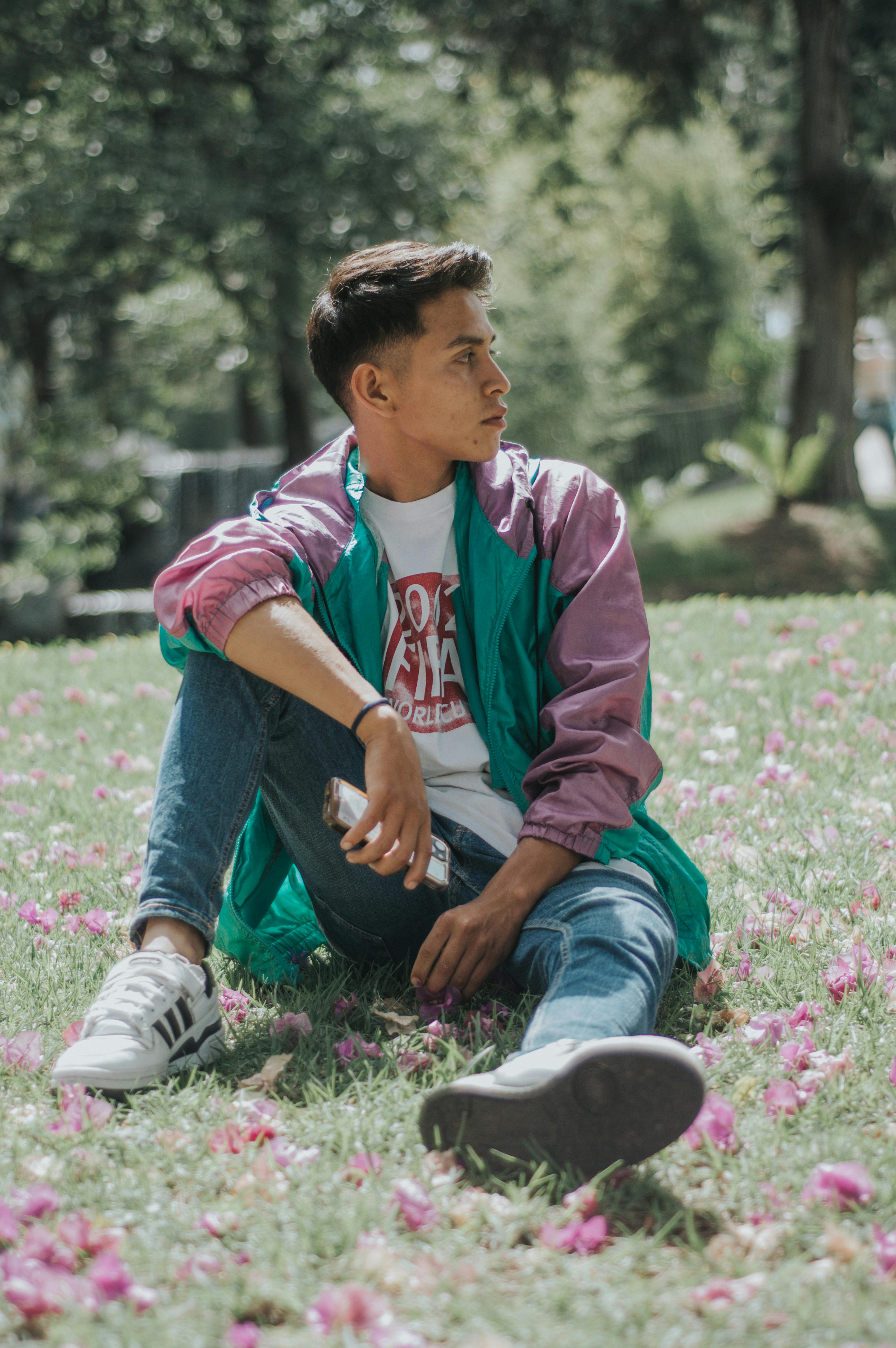 Young Man in a Casual Outfit Sitting on the Grass · Free Stock Photo
