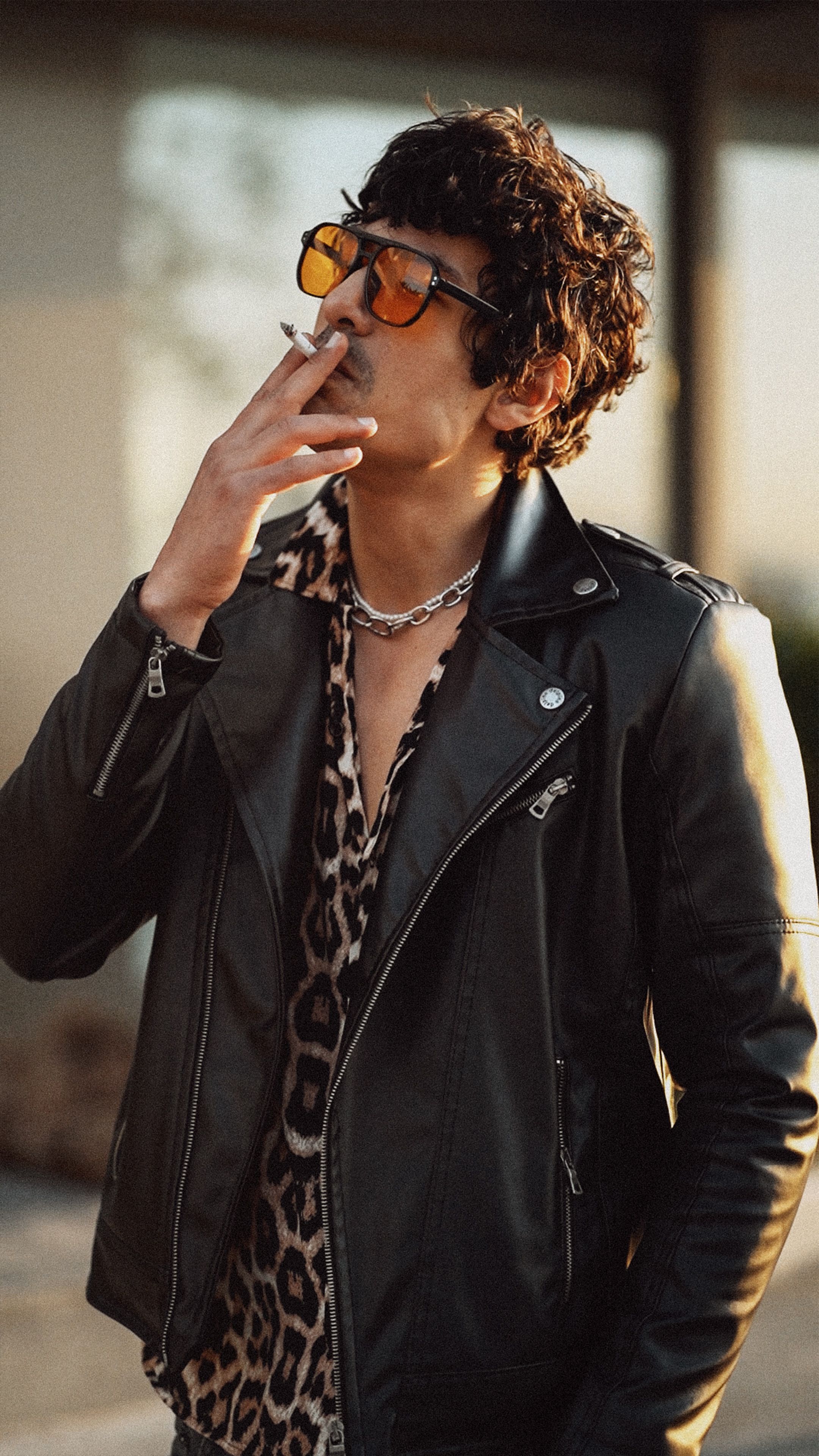 Man in Black Leather Jacket and Leopard Print Shirt Smoking a Cigarette ...