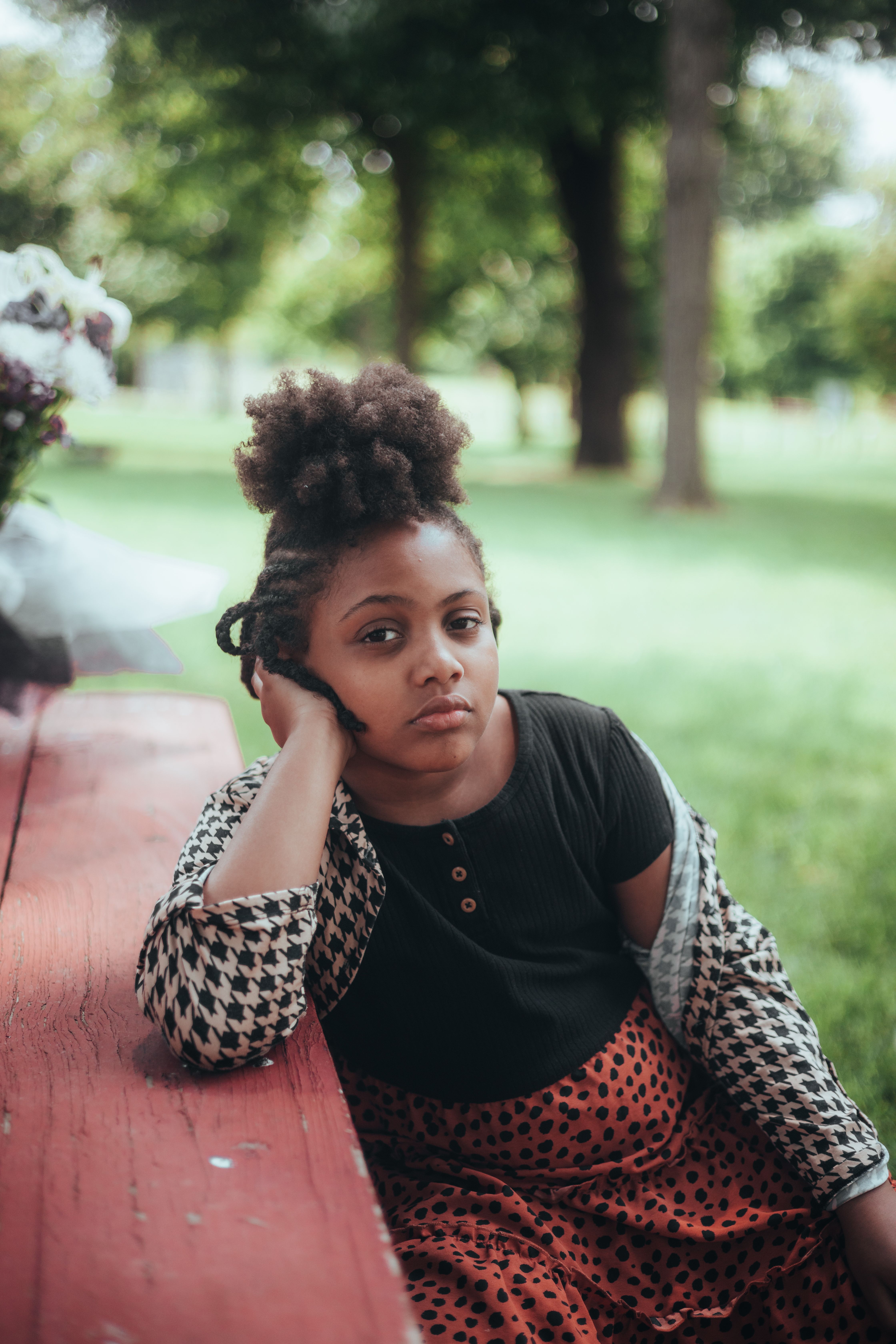 Bored Girl Sitting at Table in Yard · Free Stock Photo