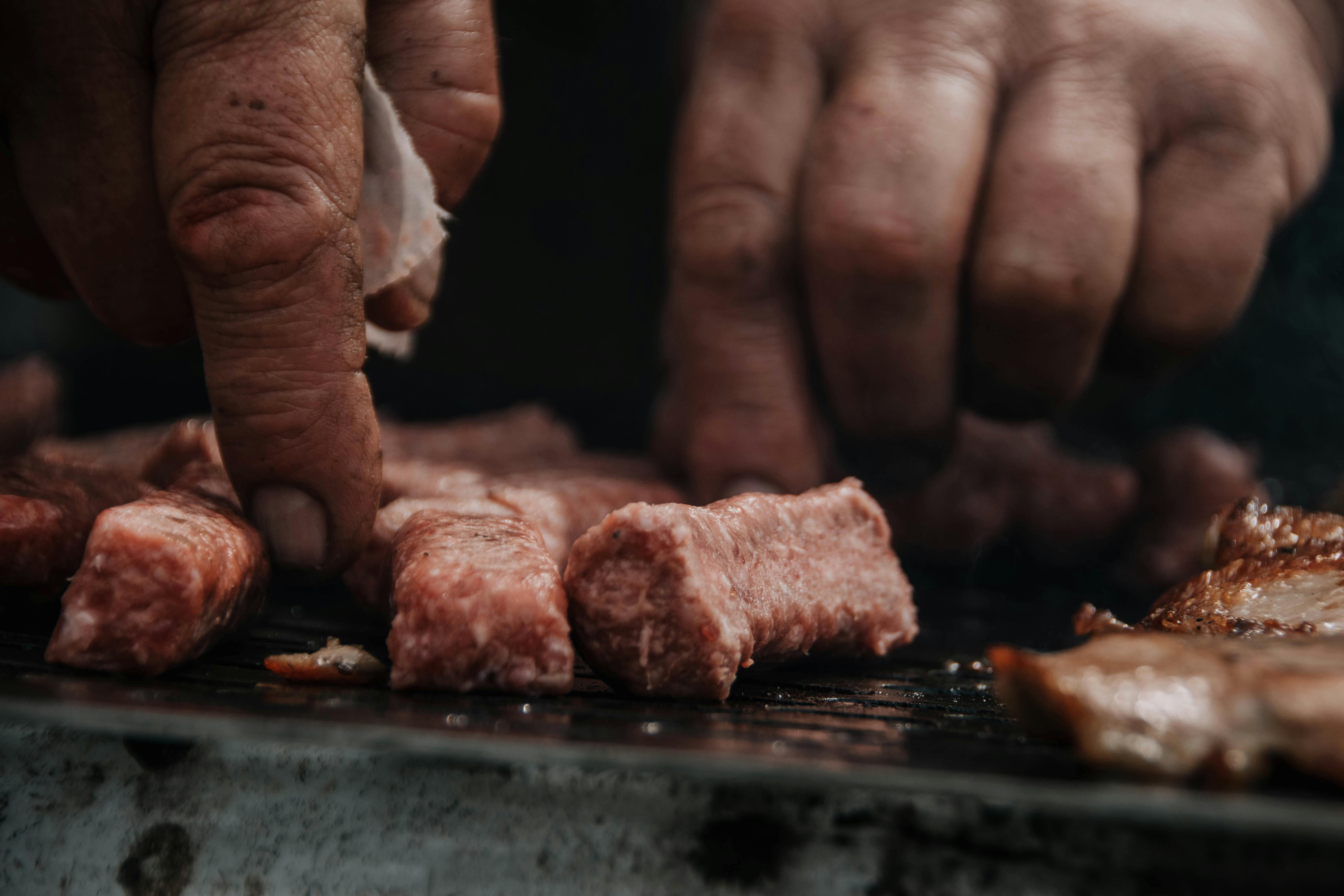 Man Fingers over Meat · Free Stock Photo