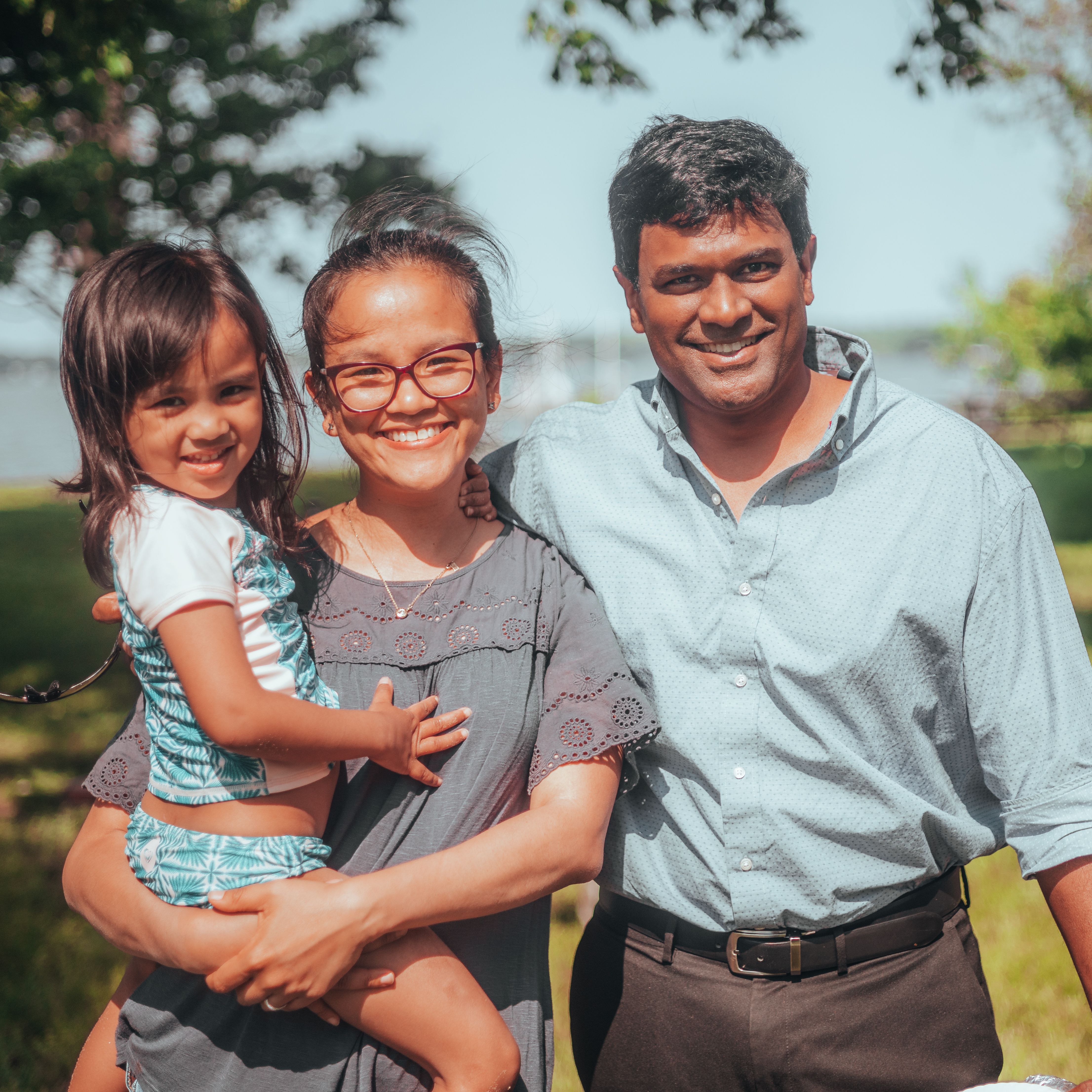 Happy Family Standing in Yard · Free Stock Photo