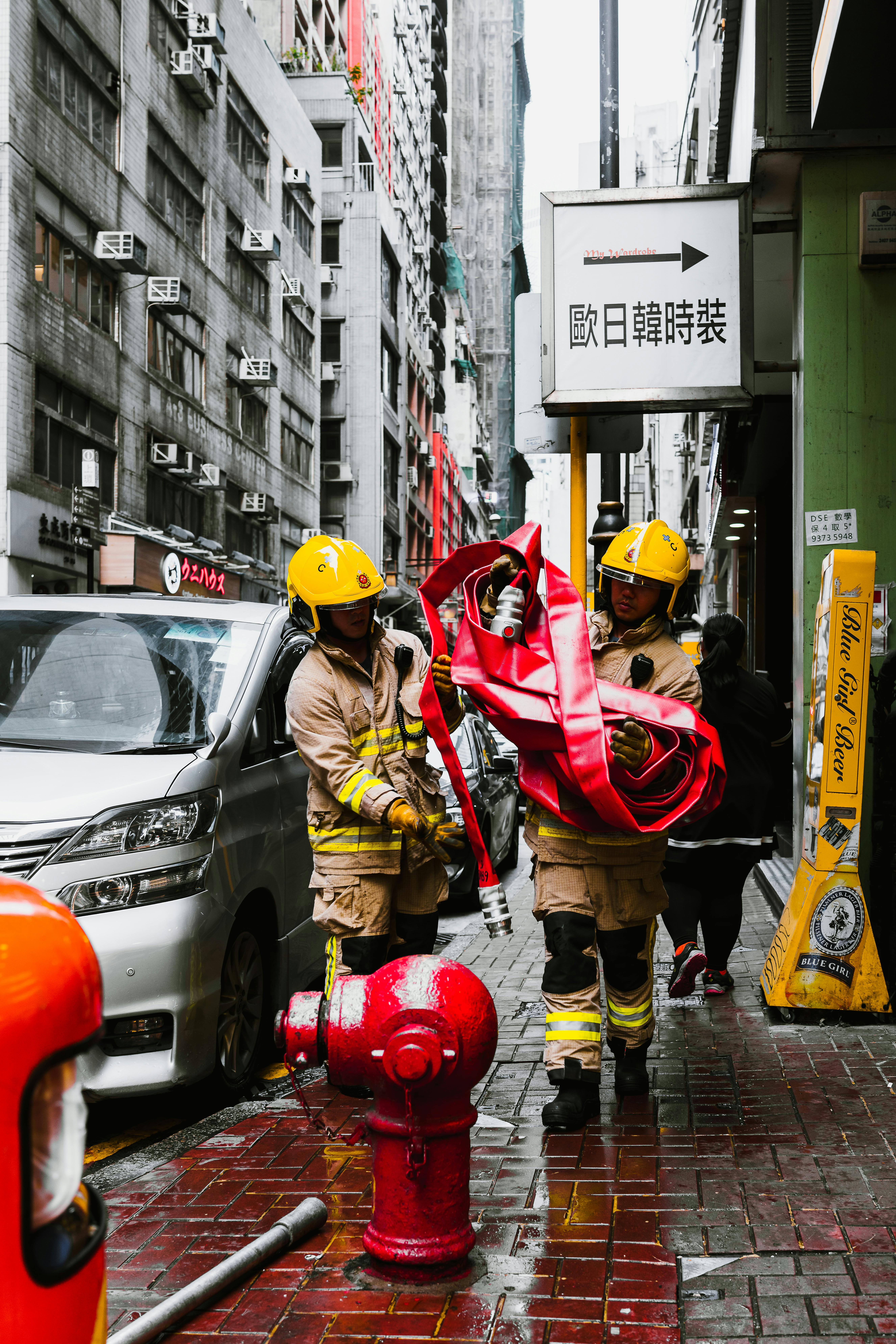 Man in White Long-sleeved Shirt Holding Red Fire Hydrant · Free Stock Photo