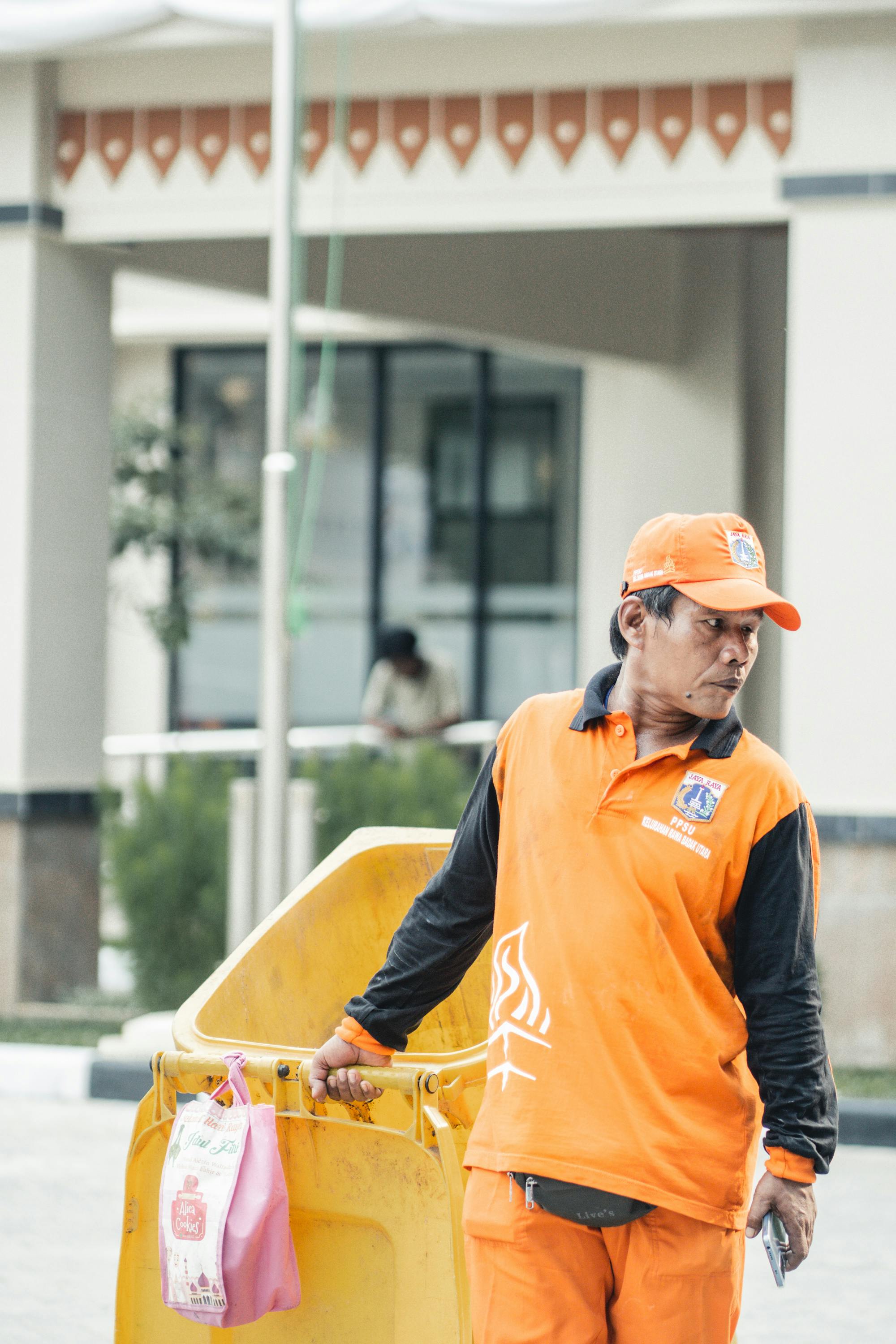 Dustman with Trash Bin · Free Stock Photo
