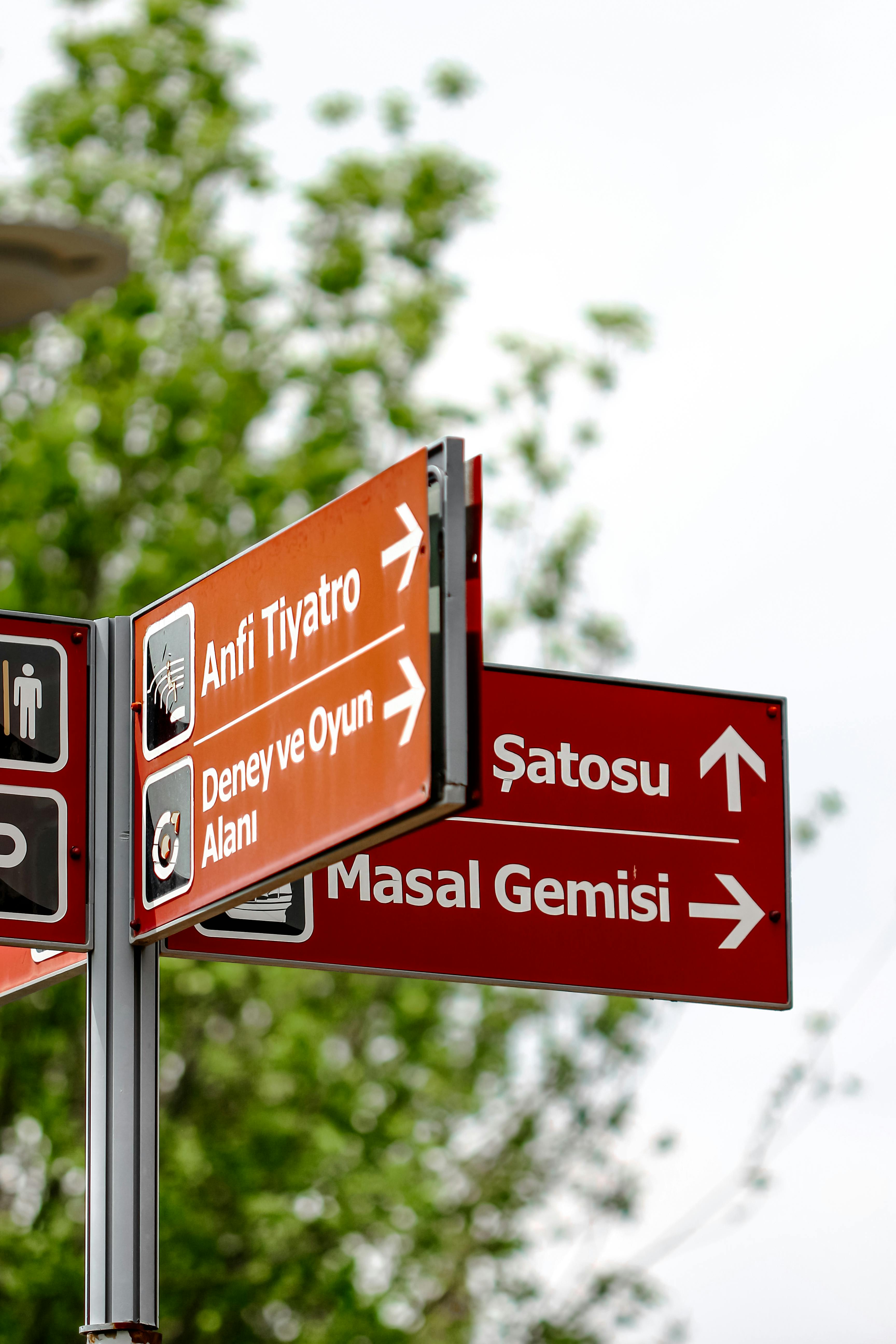 Street Name and Directional Sign on Stone Wall · Free Stock Photo
