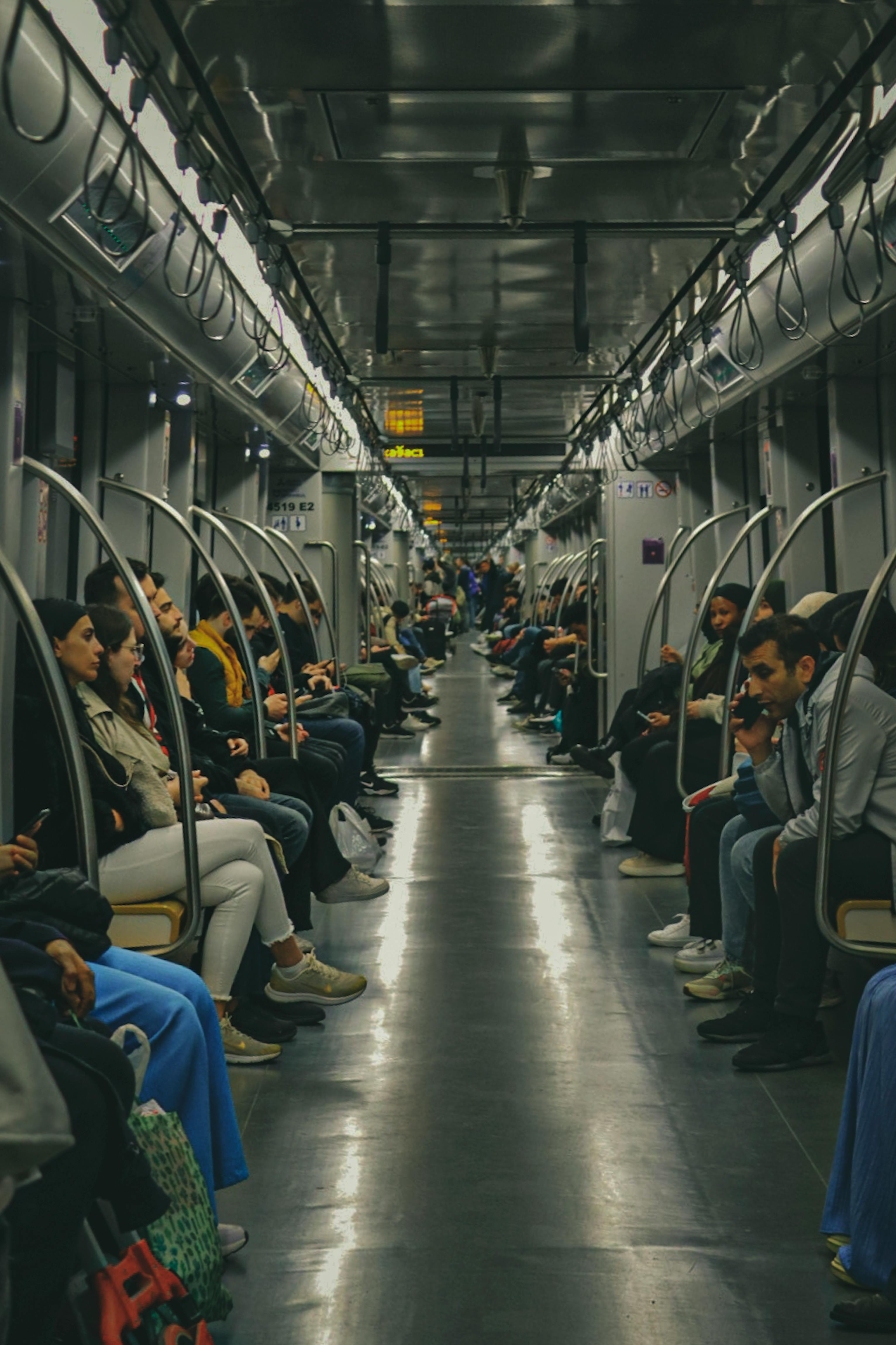 Grayscale Photo of People Inside Train · Free Stock Photo