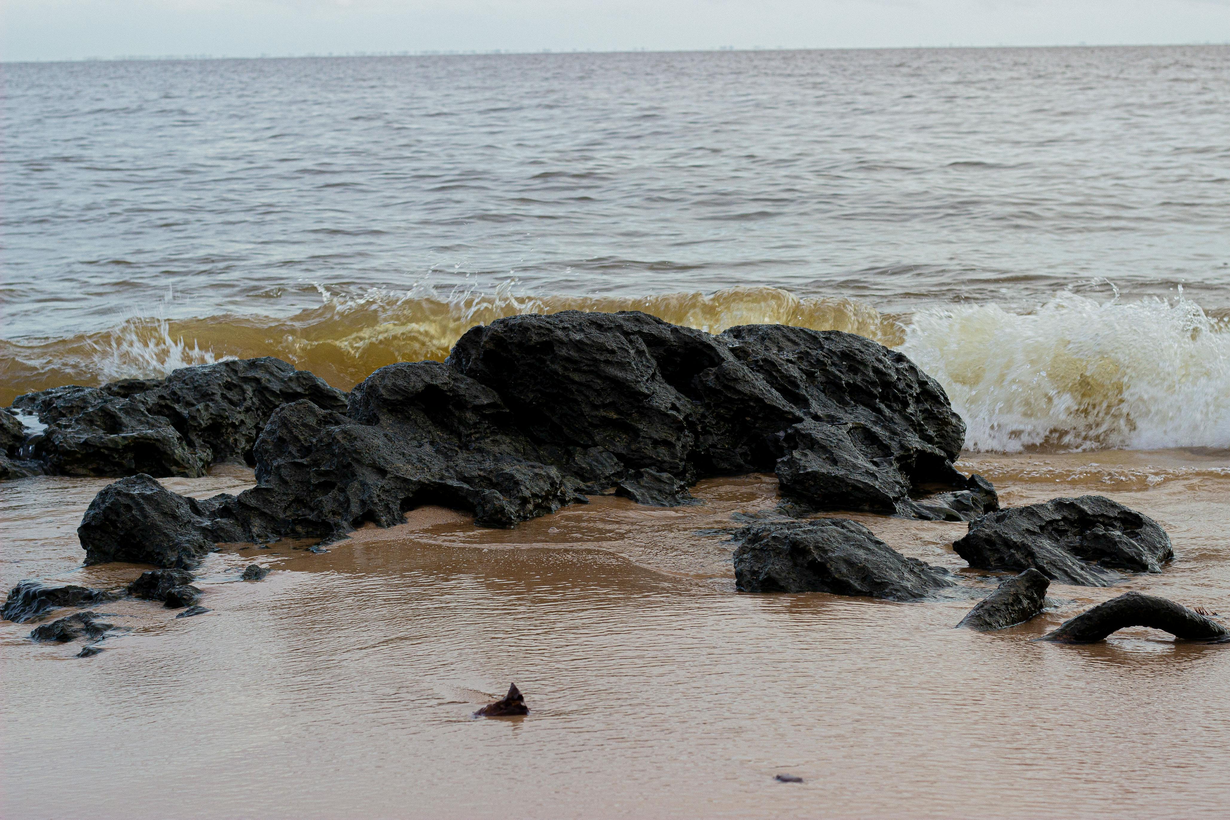Black Rock Formations on the Beach · Free Stock Photo