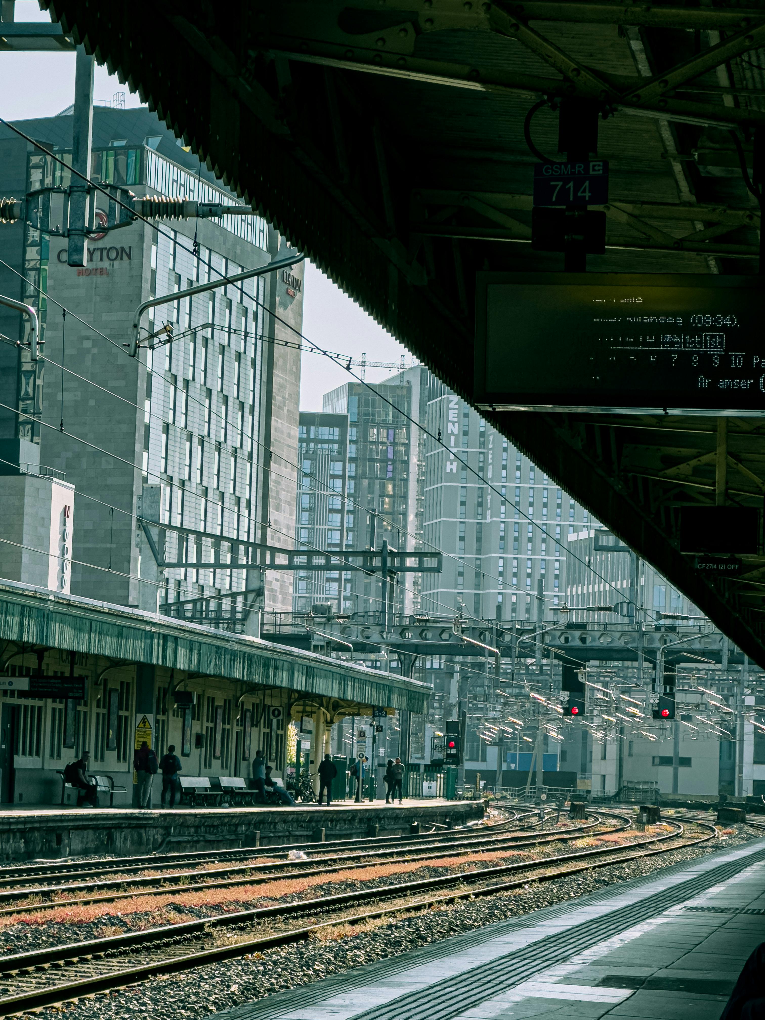 Ethnic men walking on platform near building · Free Stock Photo