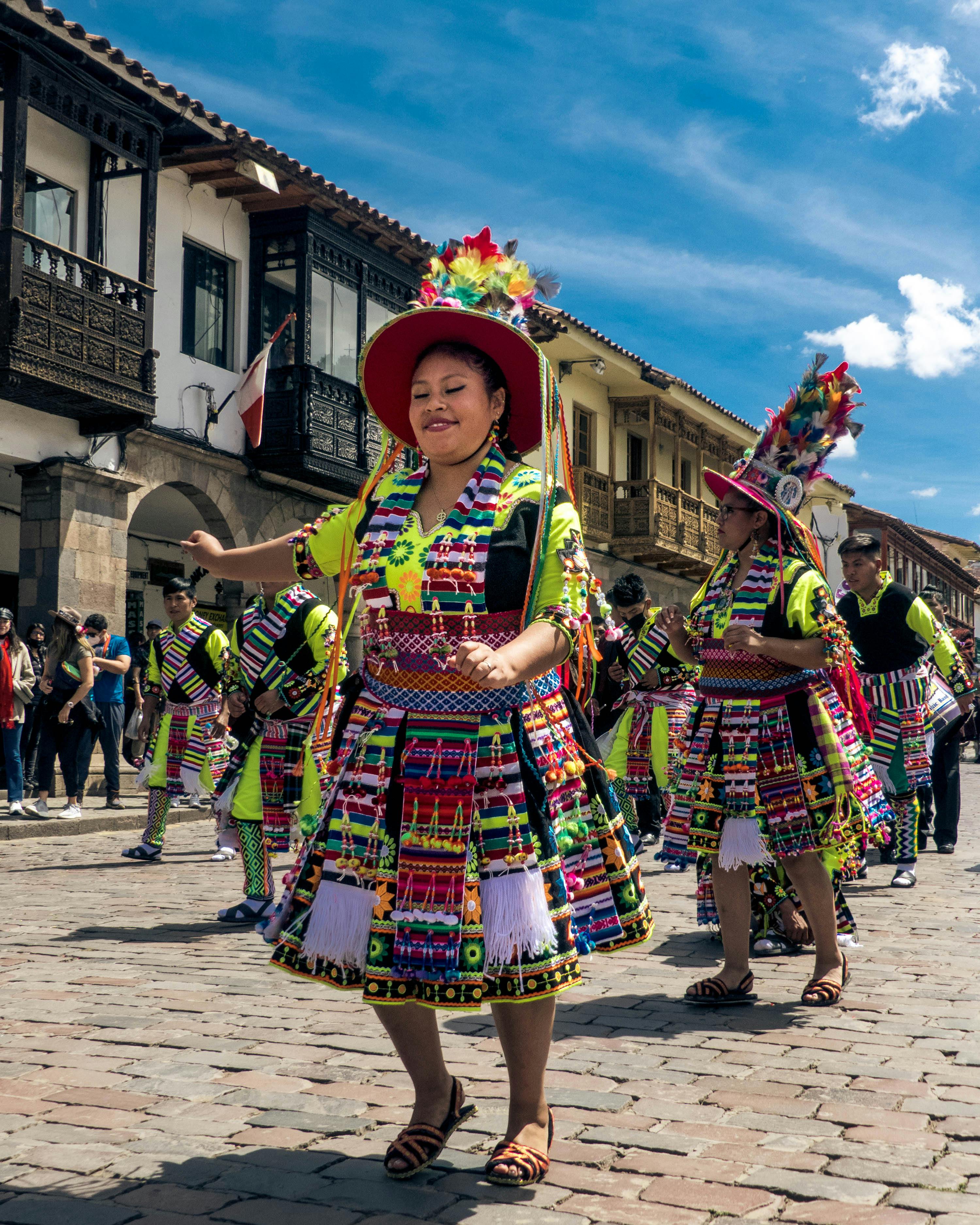 Colorful Parade of People in Traditional Clothing · Free Stock Photo