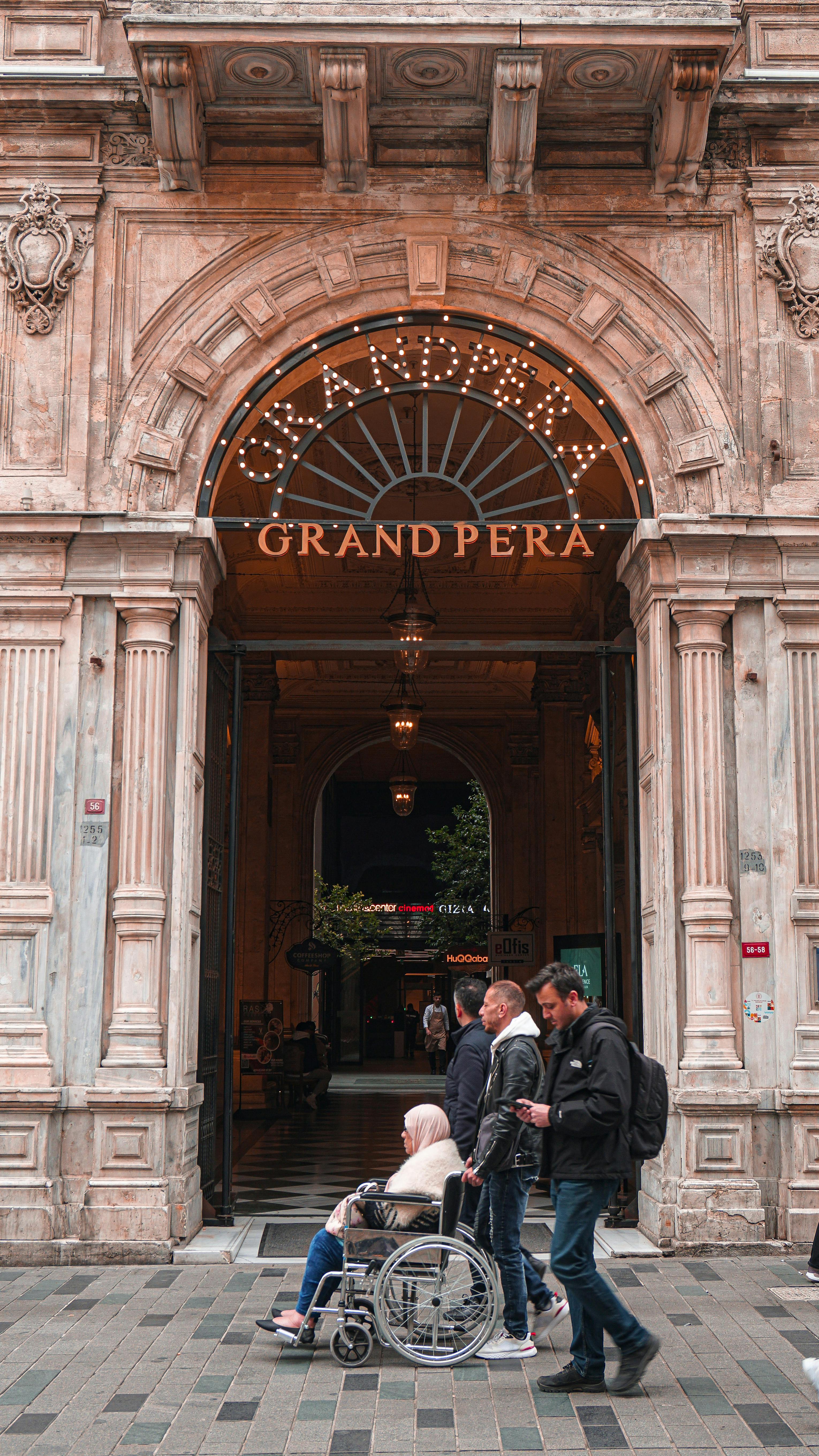 Pedestrians Passing by the Entrance to the Grand Pera Building in ...