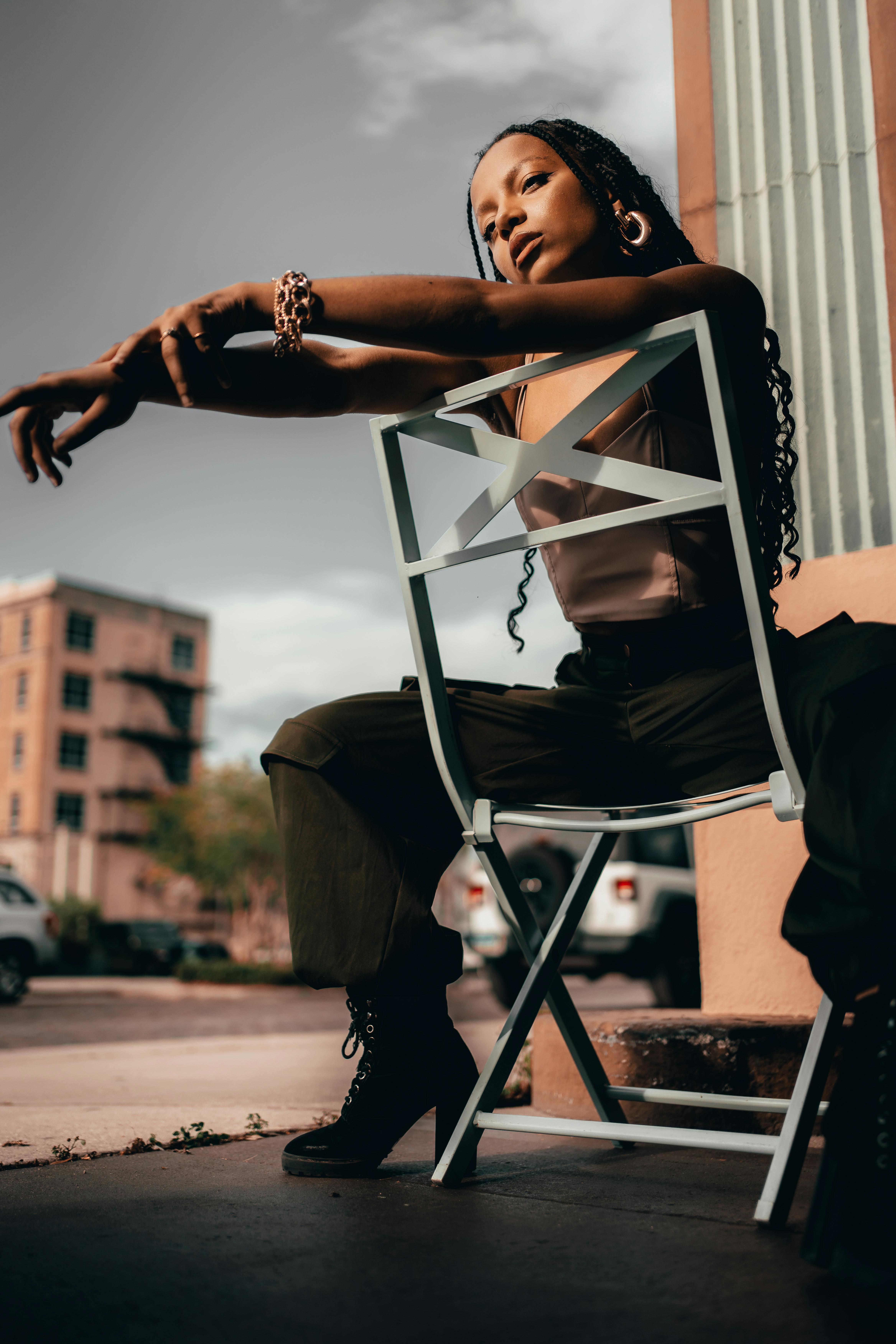 Woman Reverse Sitting in Front of a Building · Free Stock Photo
