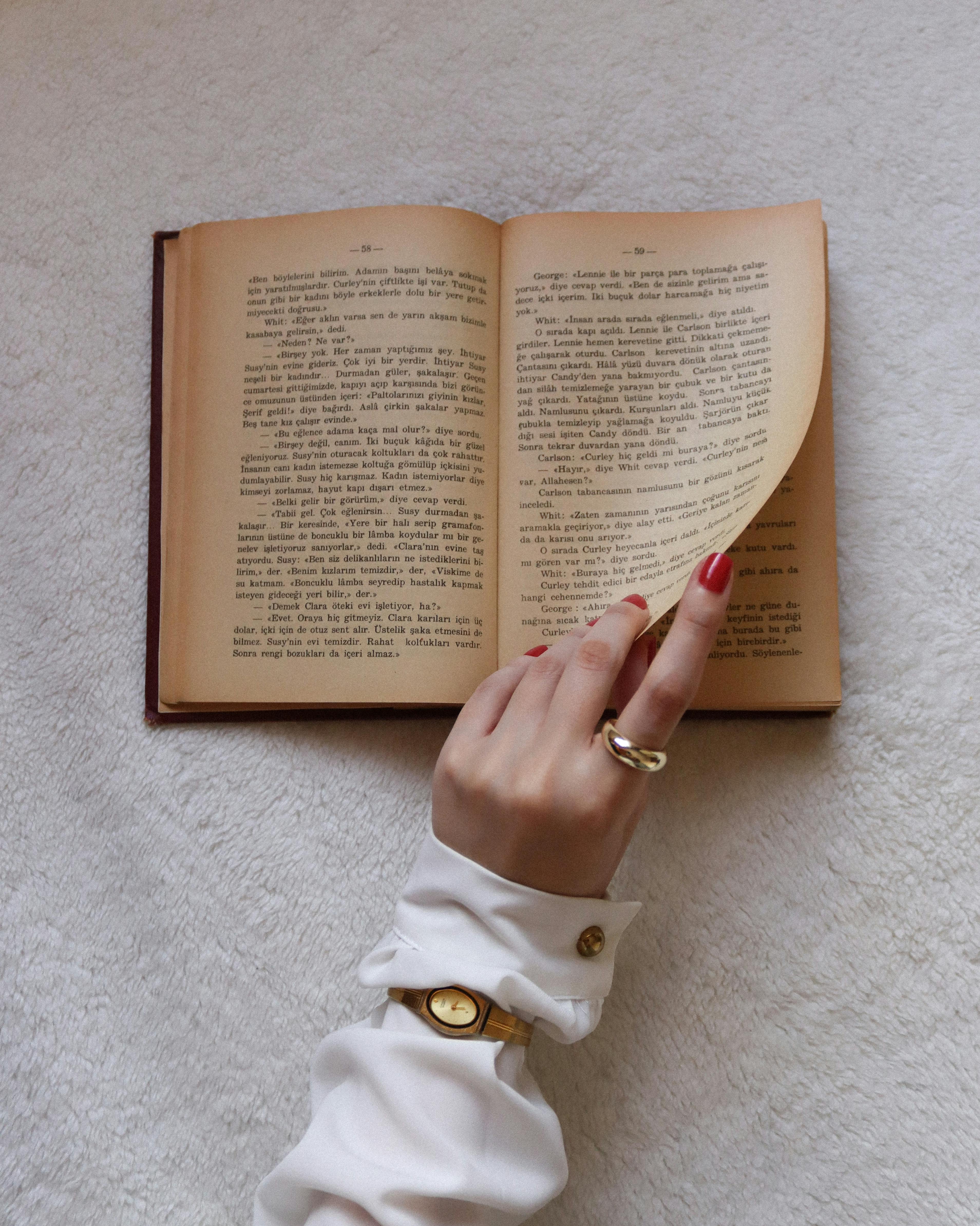 Woman Hand over Book Pages · Free Stock Photo
