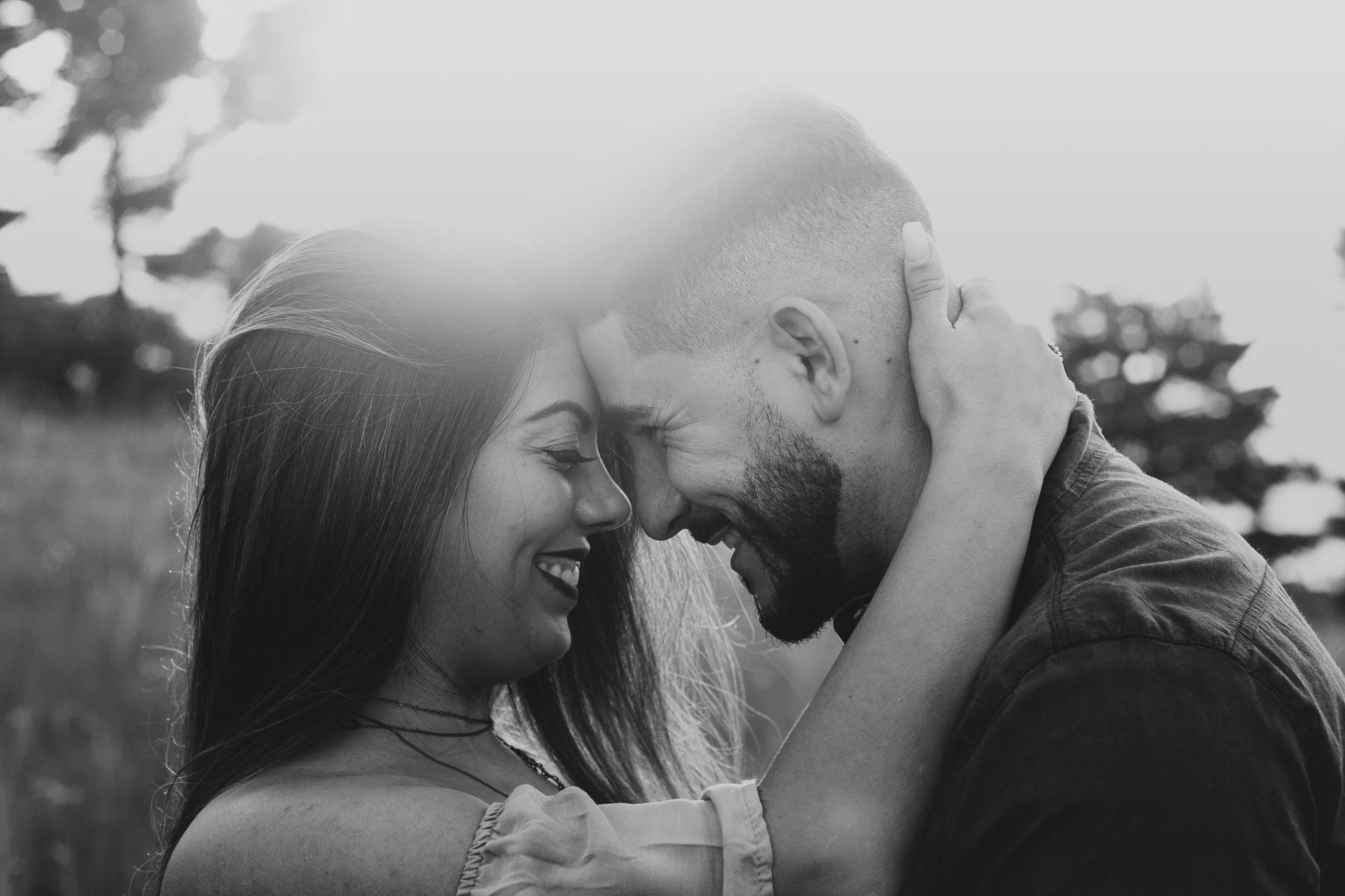 A Couple Standing Head to Head and Smiling · Free Stock Photo