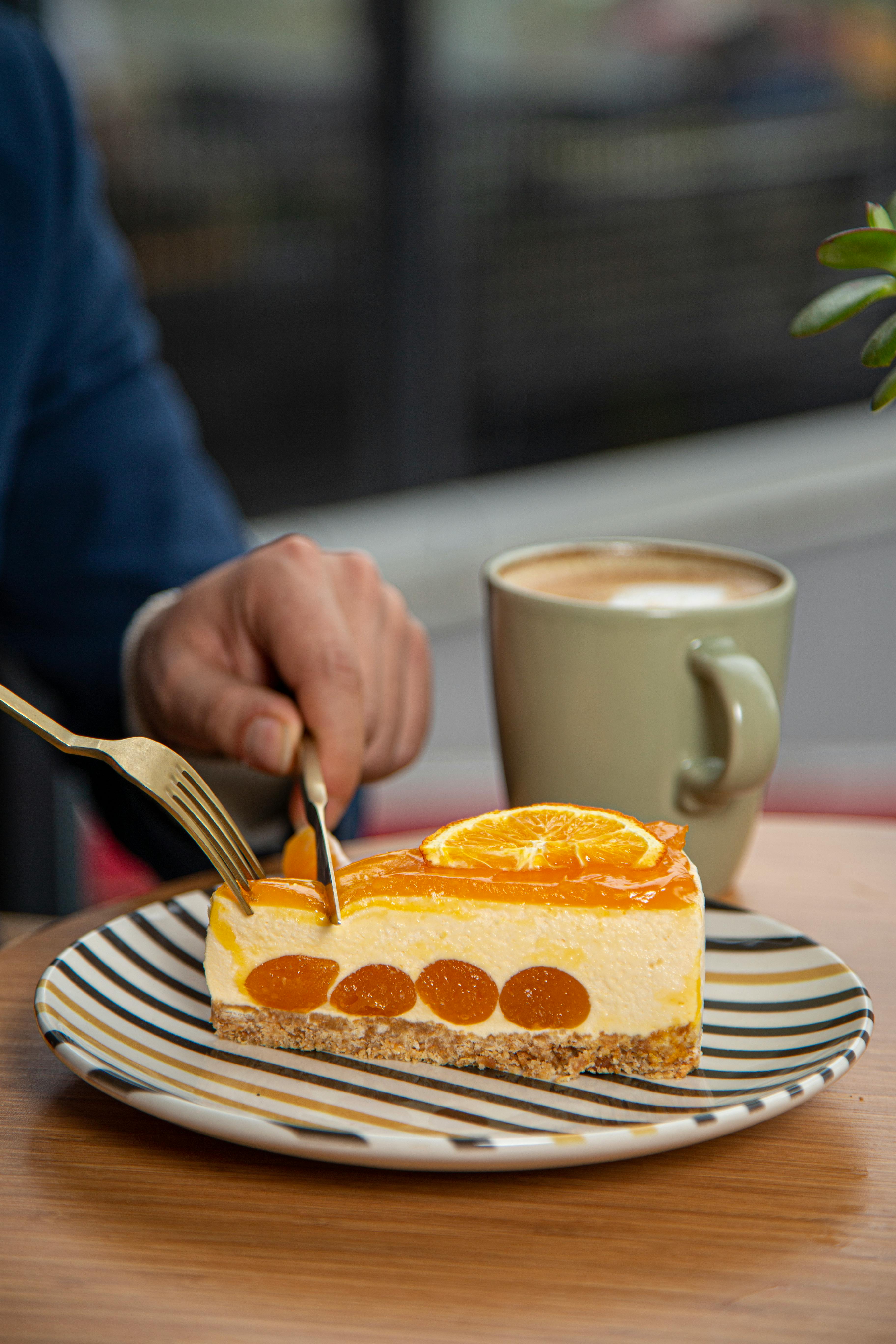 Man Eating Orange Cheesecake · Free Stock Photo