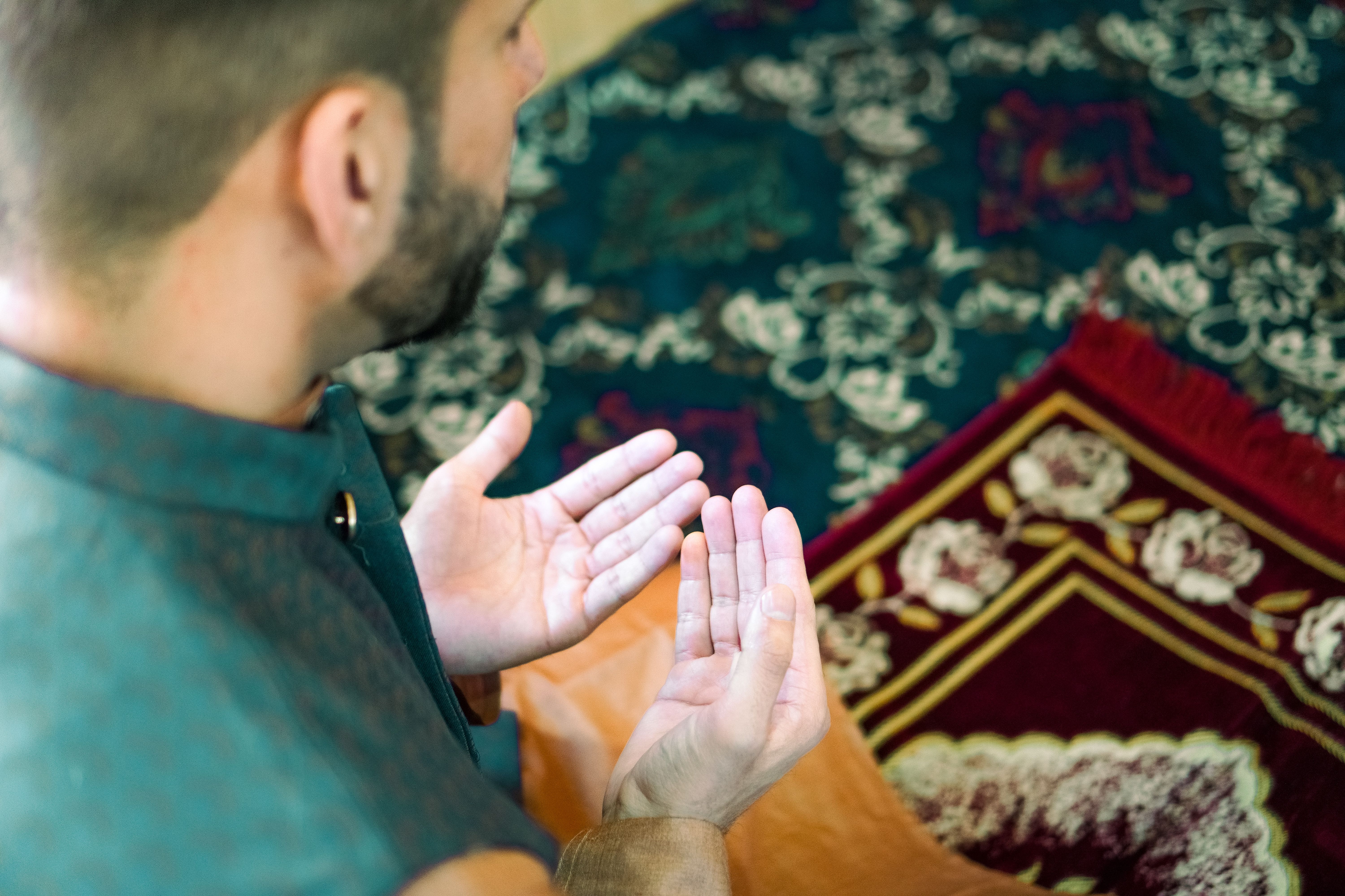 Man Praying Kneeling on the Carpet · Free Stock Photo