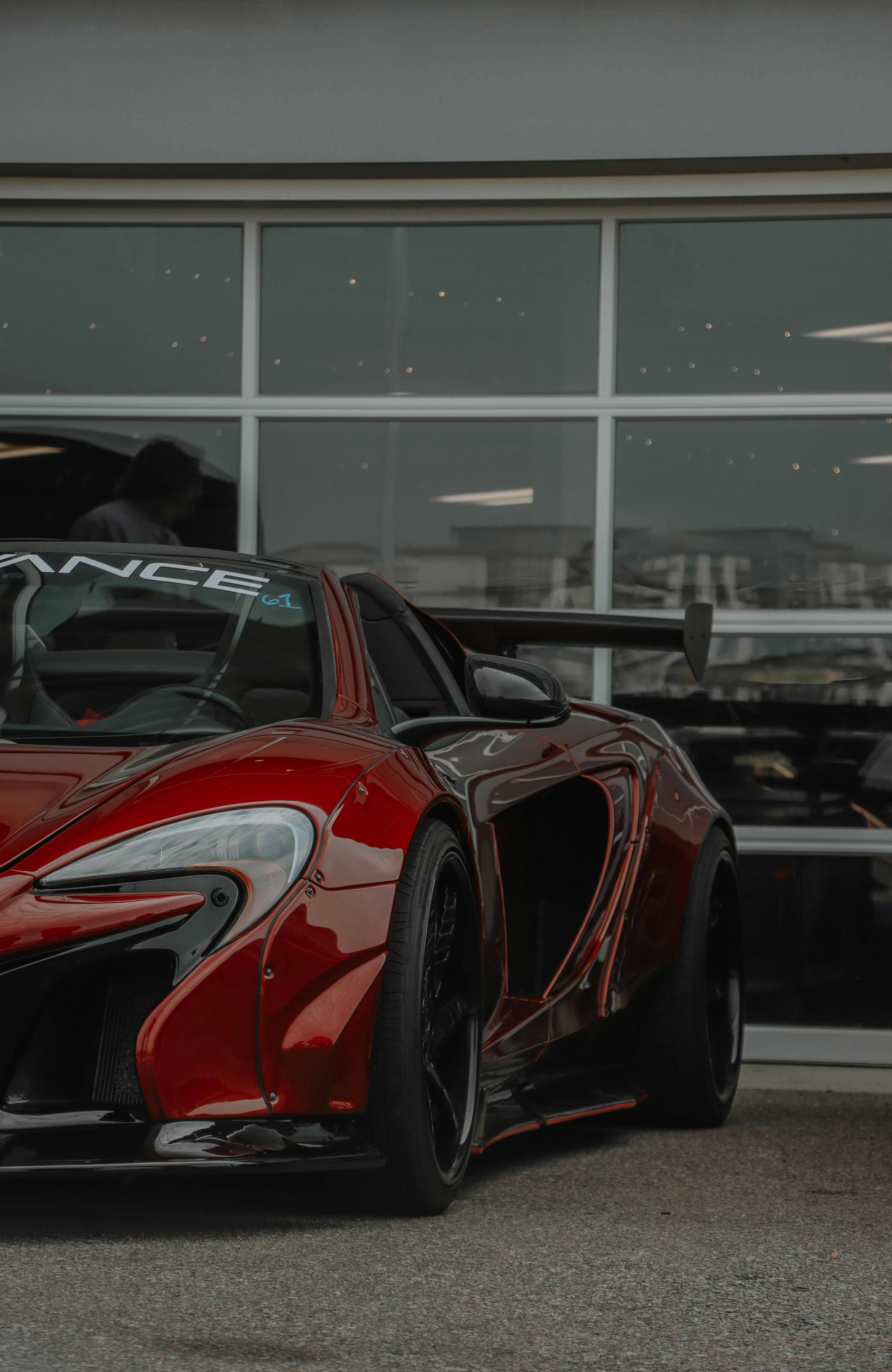 Striking Red McLaren Supercar in Urban Setting · Free Stock Photo