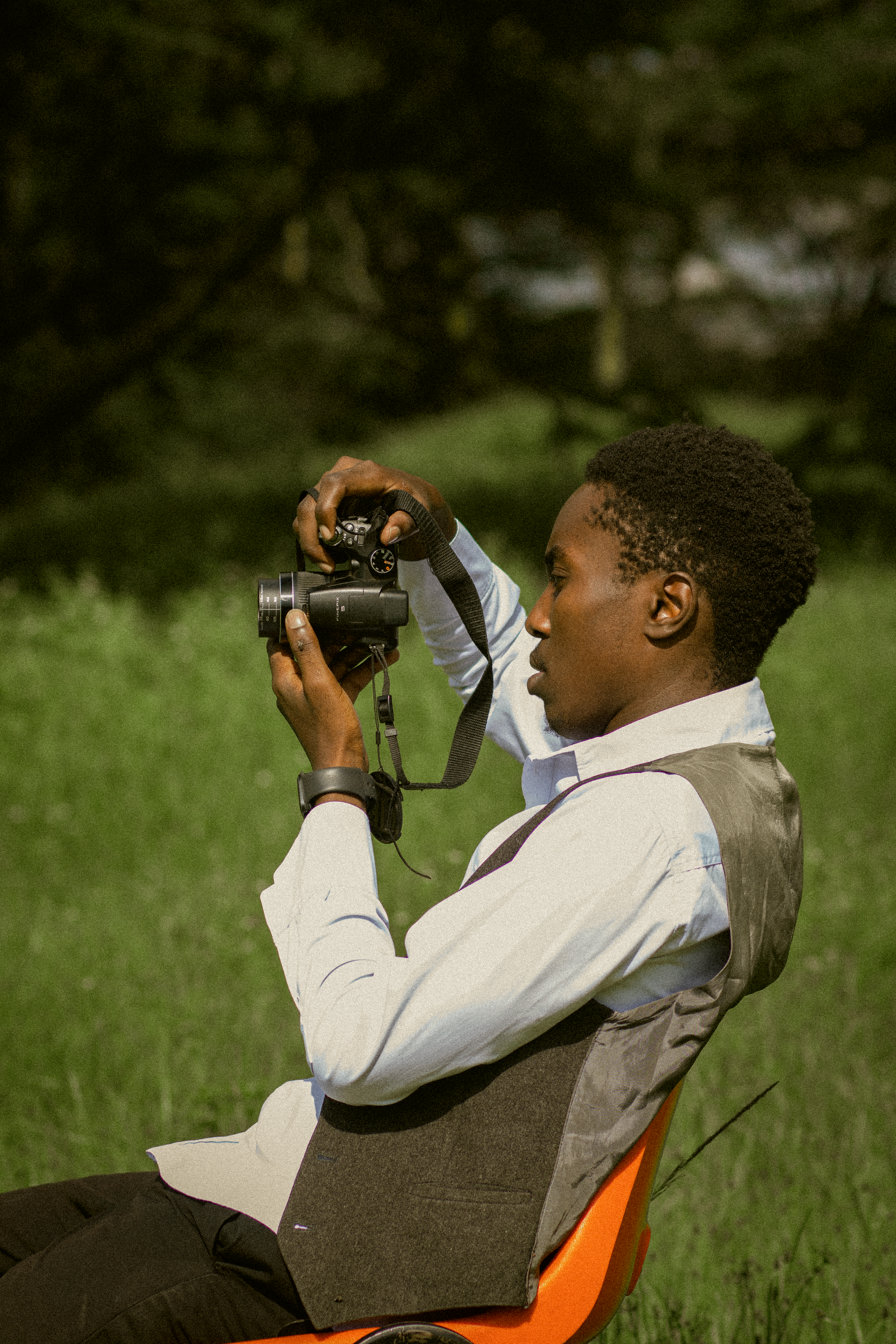 Man in Shirt Sitting with Camera · Free Stock Photo