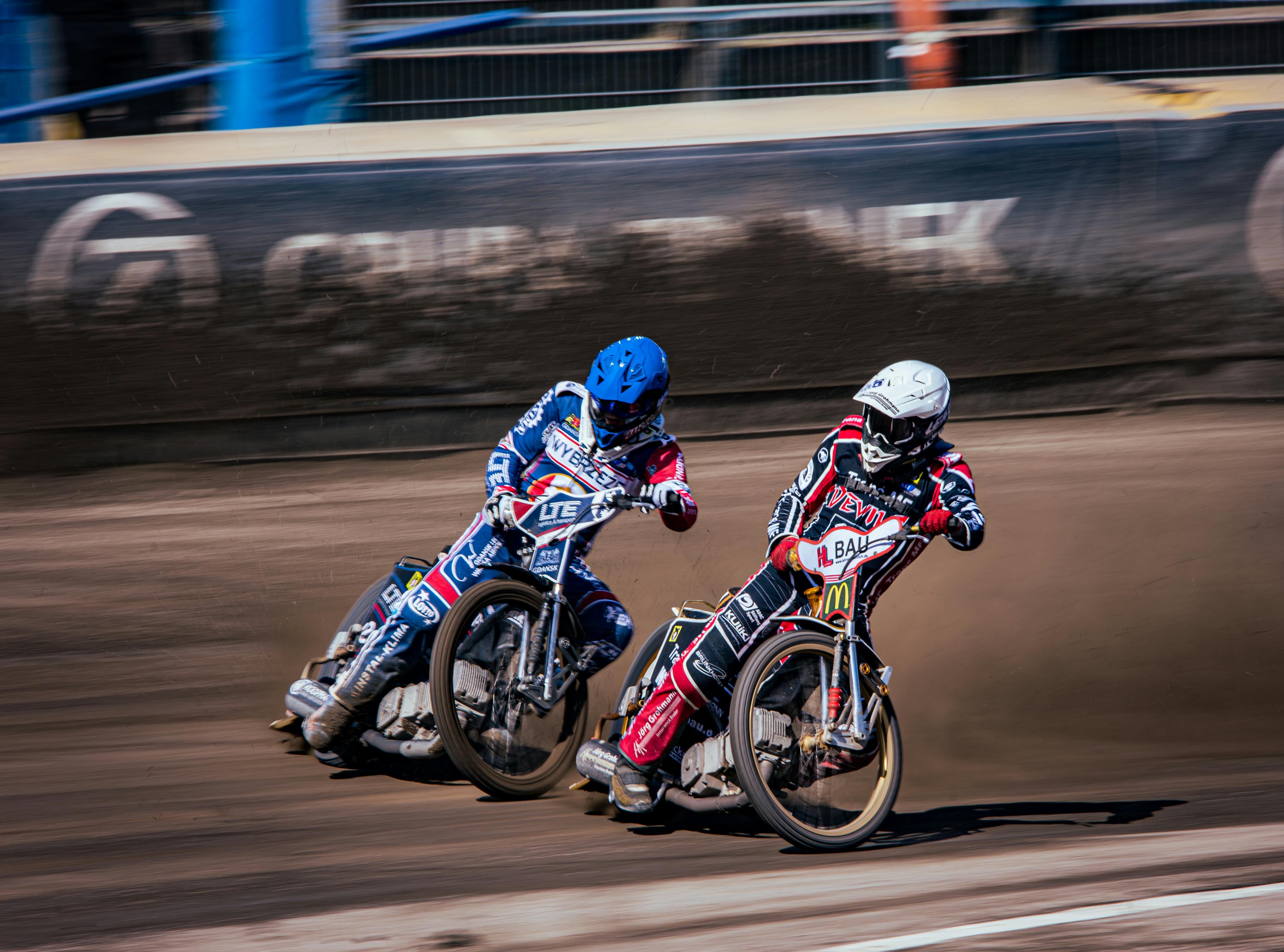 Two motorcyclists racing on a dirt track · Free Stock Photo