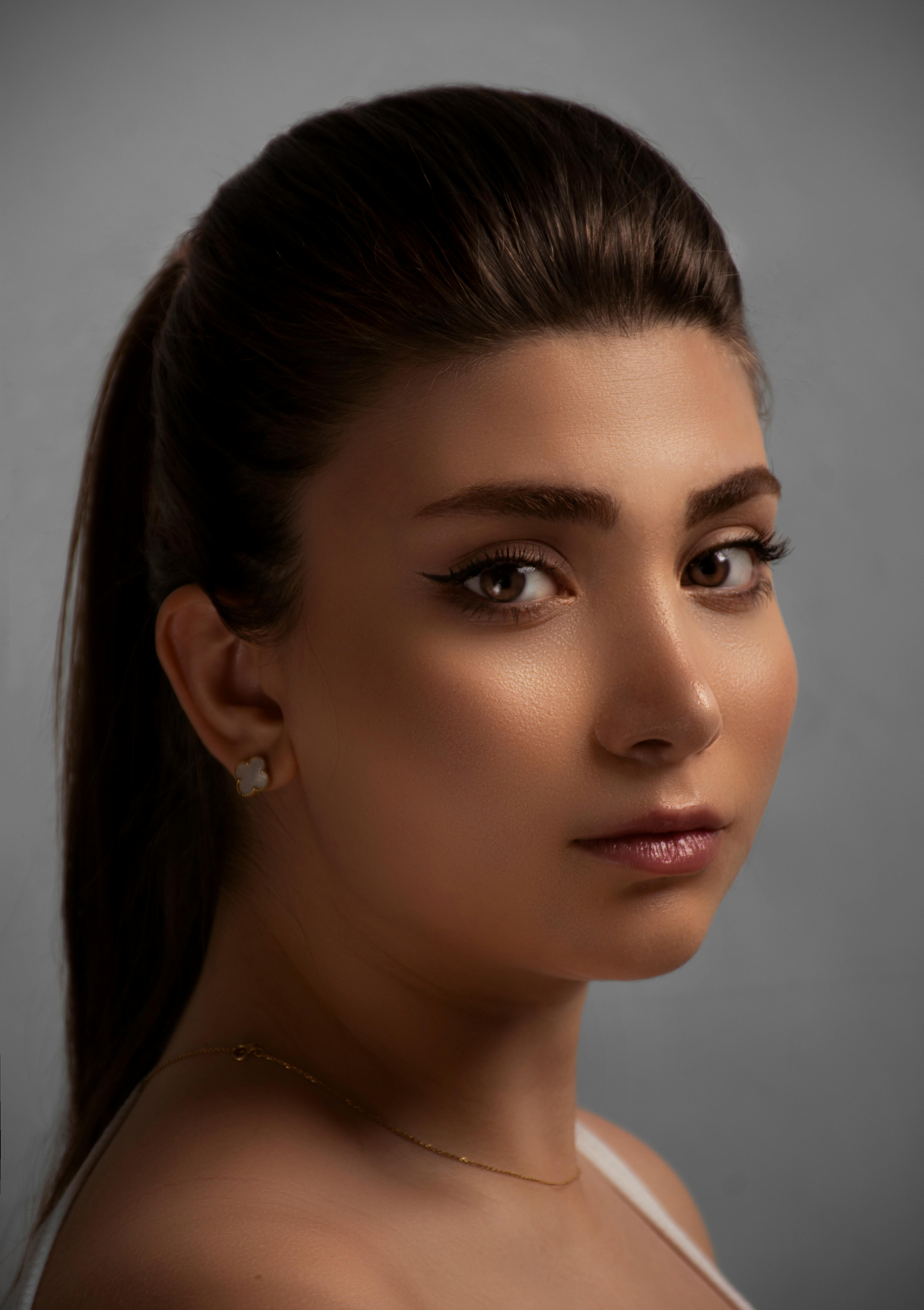 Portrait of Woman Against Black Background · Free Stock Photo